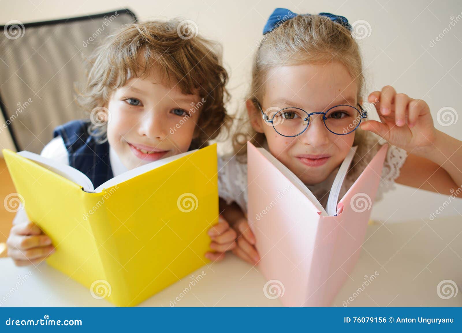 Two Young Classmate, Boy and Girl, are Sitting at the Same Desk. Stock ...