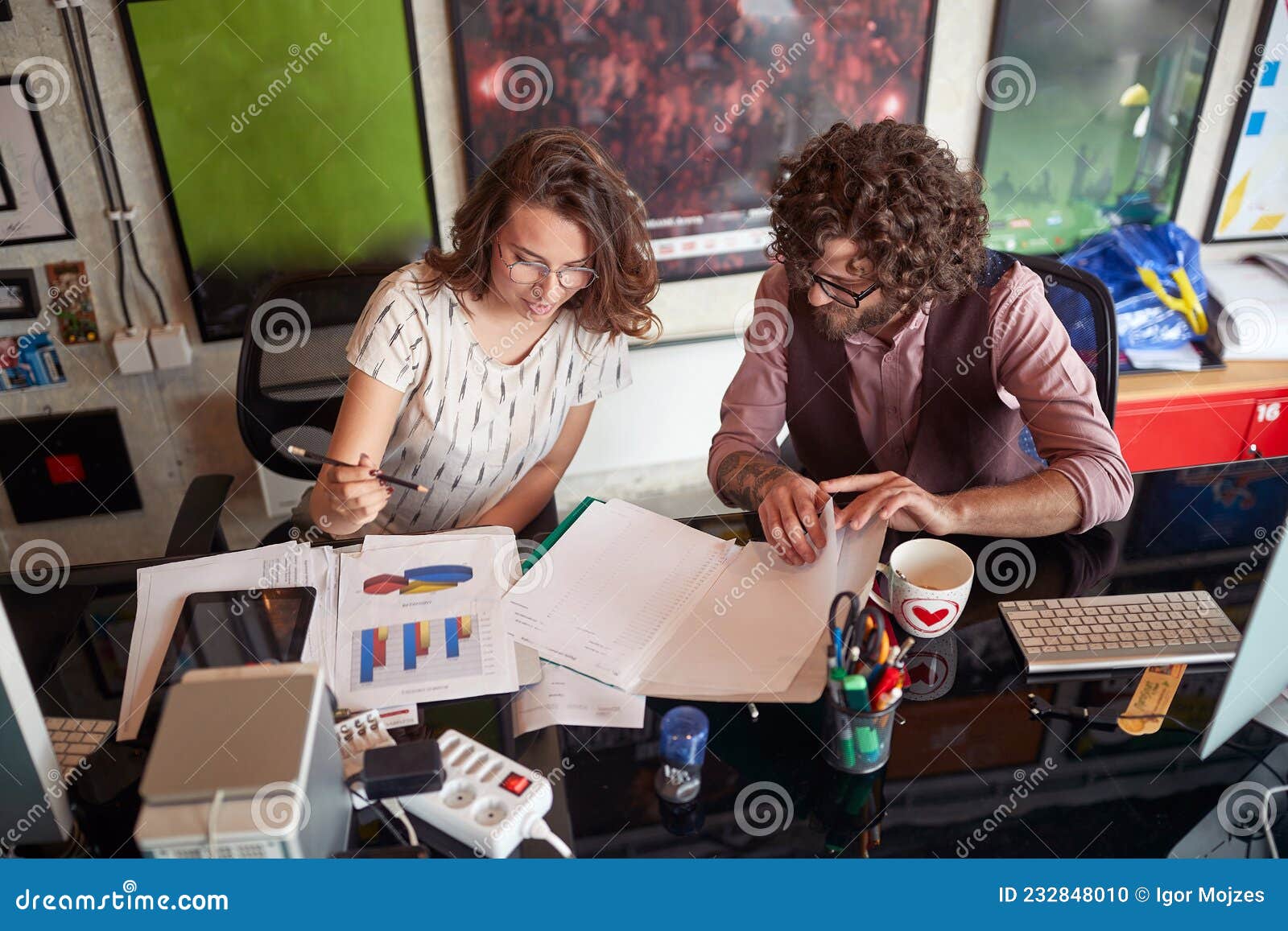 Two Young Colleagues Doing Paperwork Together Stock Photo - Image of ...