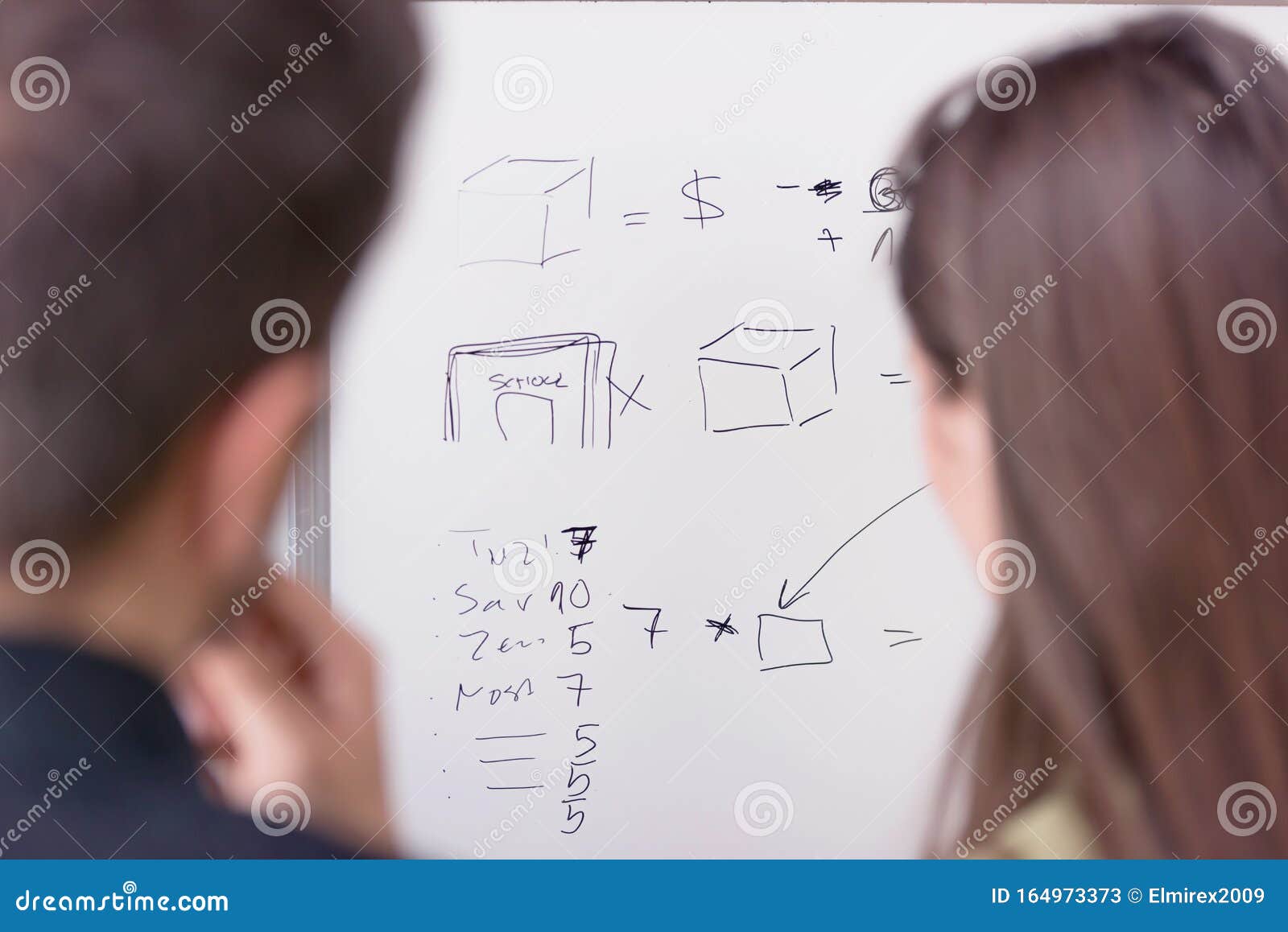 Two Young College Male and Female Students Writting on the Chalkboard ...