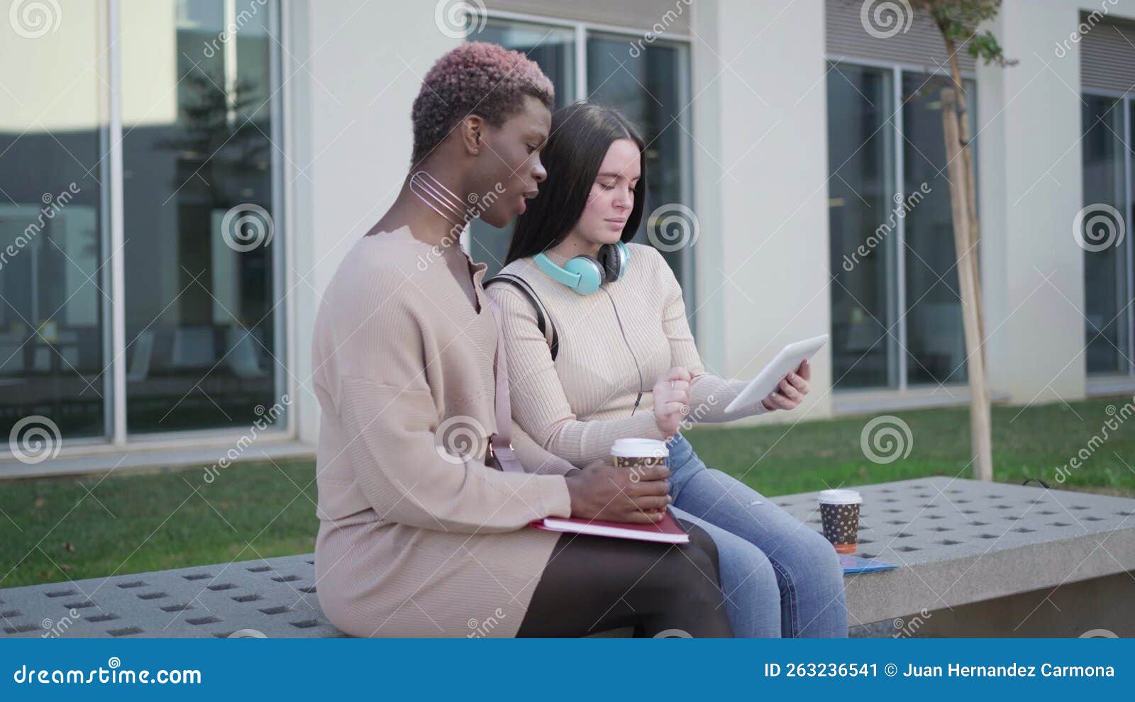 Two Young College Students Review Notes on the Tablet Sitting on the ...