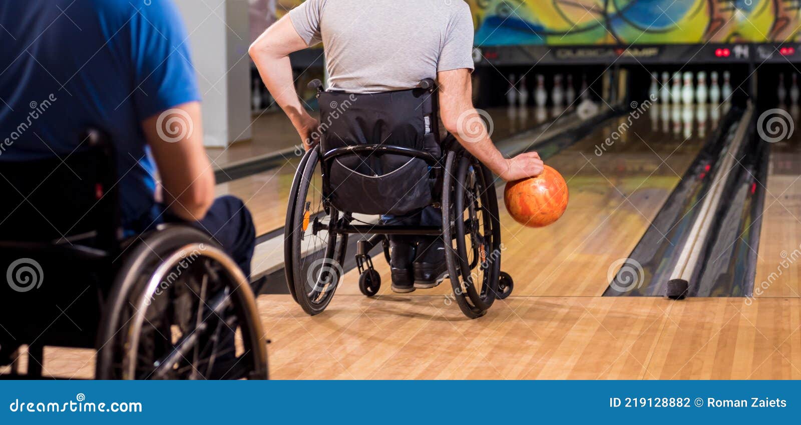 Two Young Disabled Men in Wheelchairs Playing Bowling in the Club Stock ...