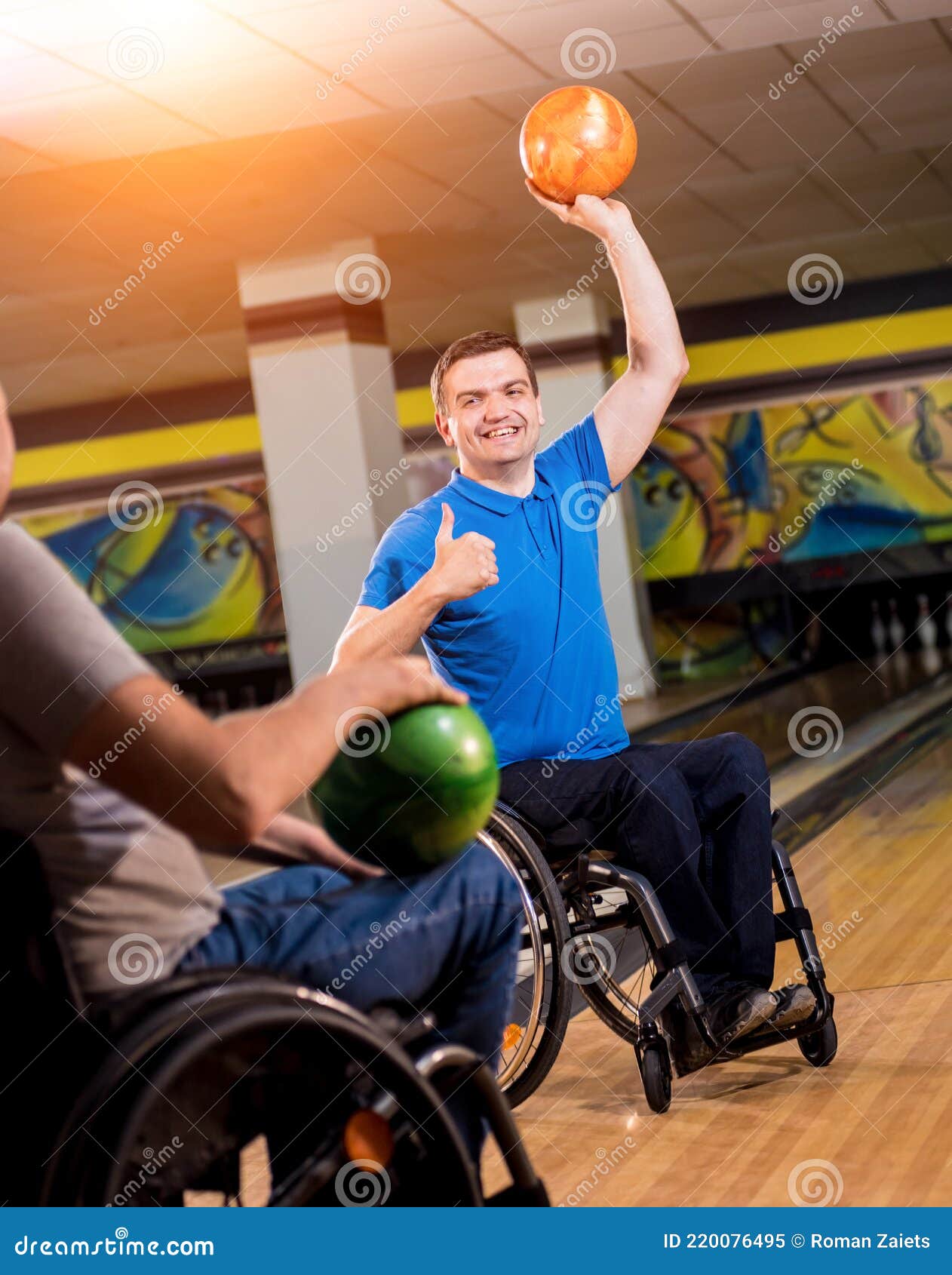 Two Young Disabled Men in Wheelchairs Playing Bowling in the Club Stock ...