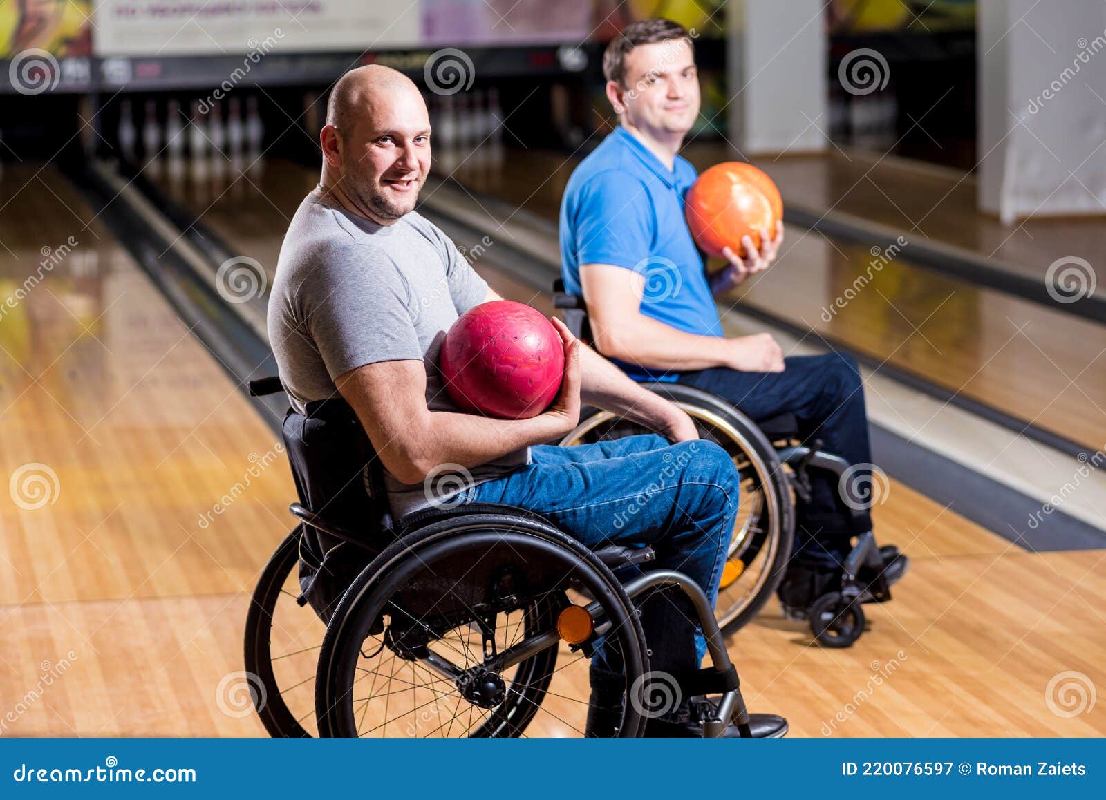 Two Young Disabled Men in Wheelchairs Playing Bowling in the Club Stock ...