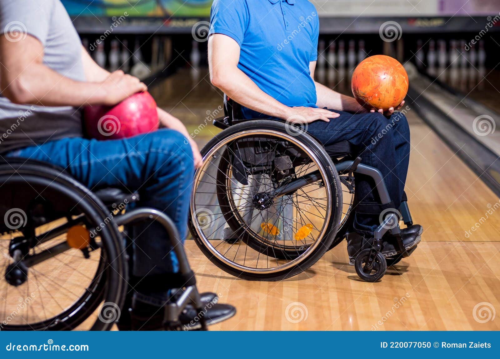 Two Young Disabled Men in Wheelchairs Playing Bowling in the Club Stock ...