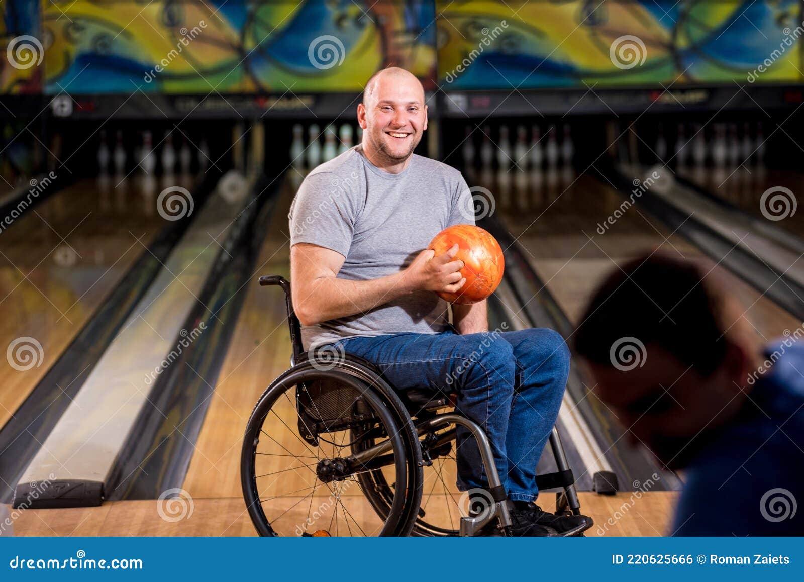 Two Young Disabled Men in Wheelchairs Playing Bowling in the Club Stock ...