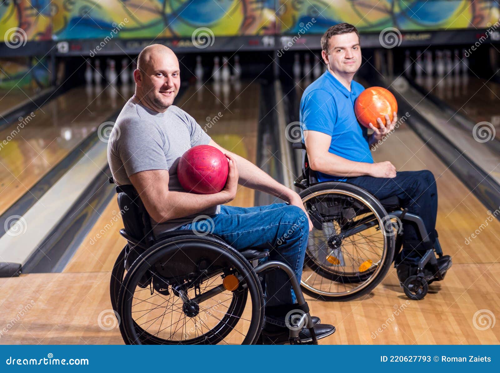 Two Young Disabled Men in Wheelchairs Playing Bowling in the Club Stock ...