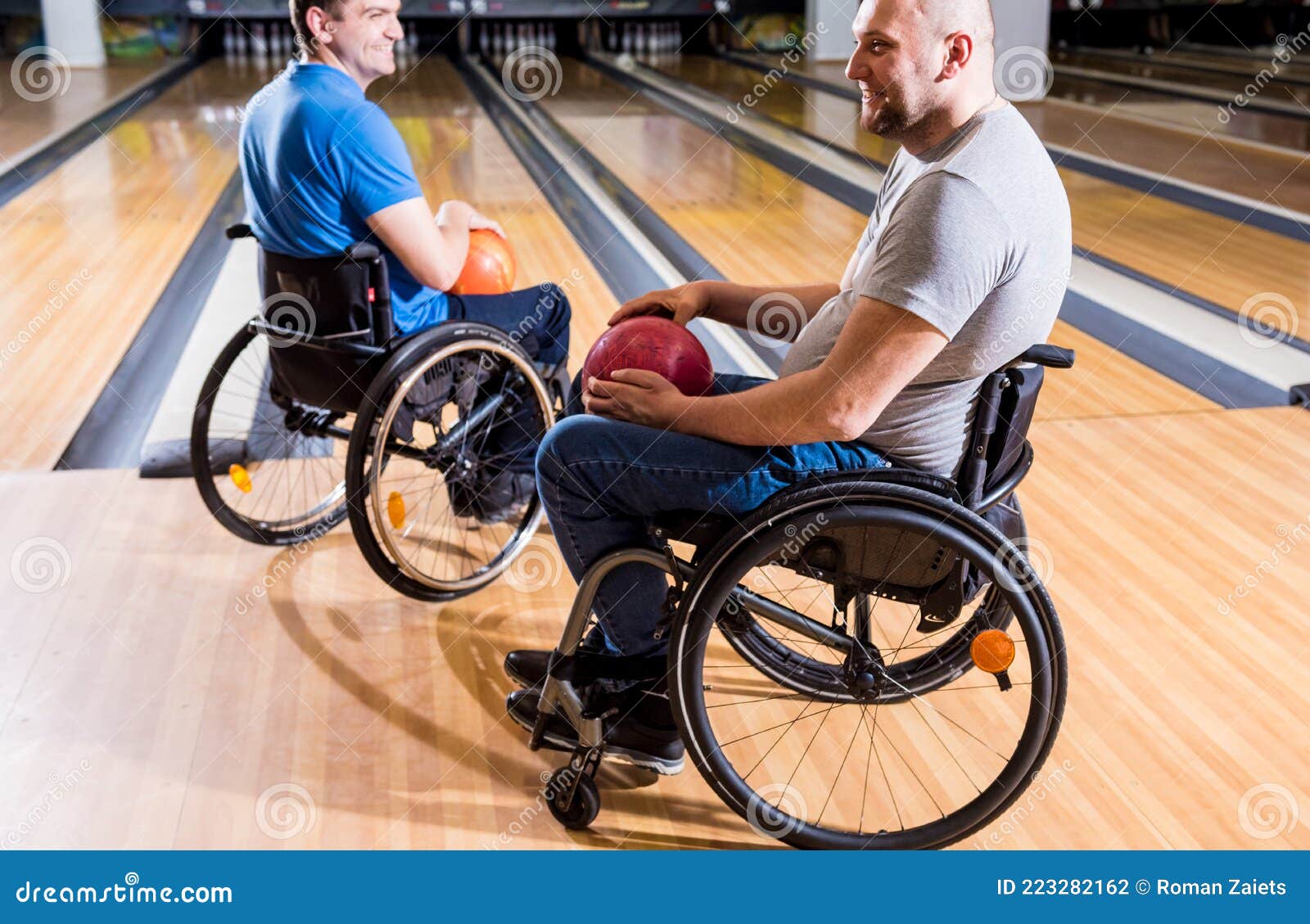 Two Young Disabled Men in Wheelchairs Playing Bowling in the Club Stock ...