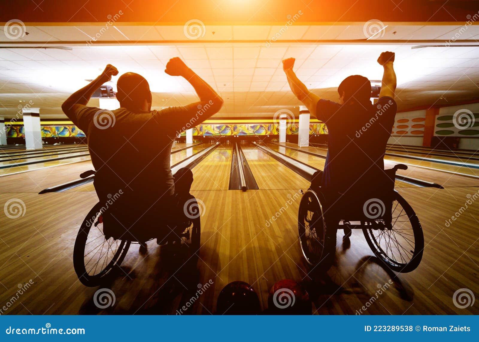 Two Young Disabled Men in Wheelchairs Playing Bowling in the Club Stock ...