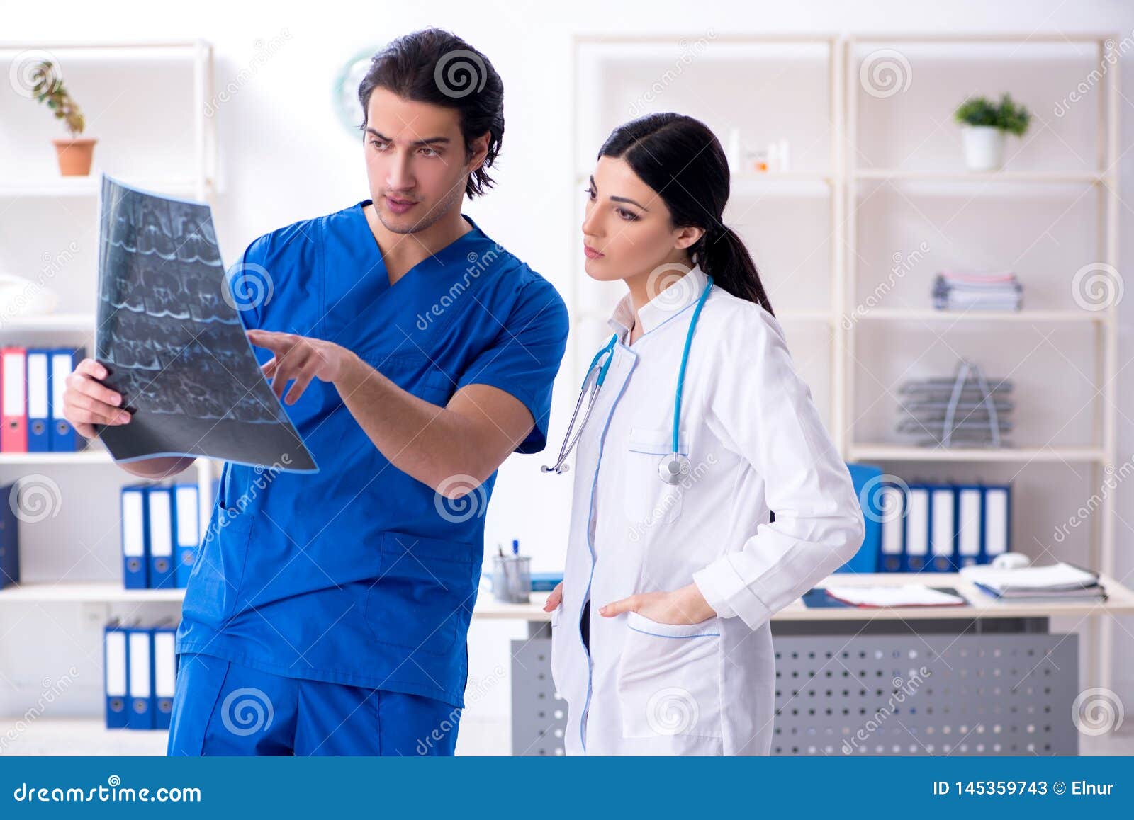 The Two Young Doctors Working in the Clinic Stock Image - Image of ...