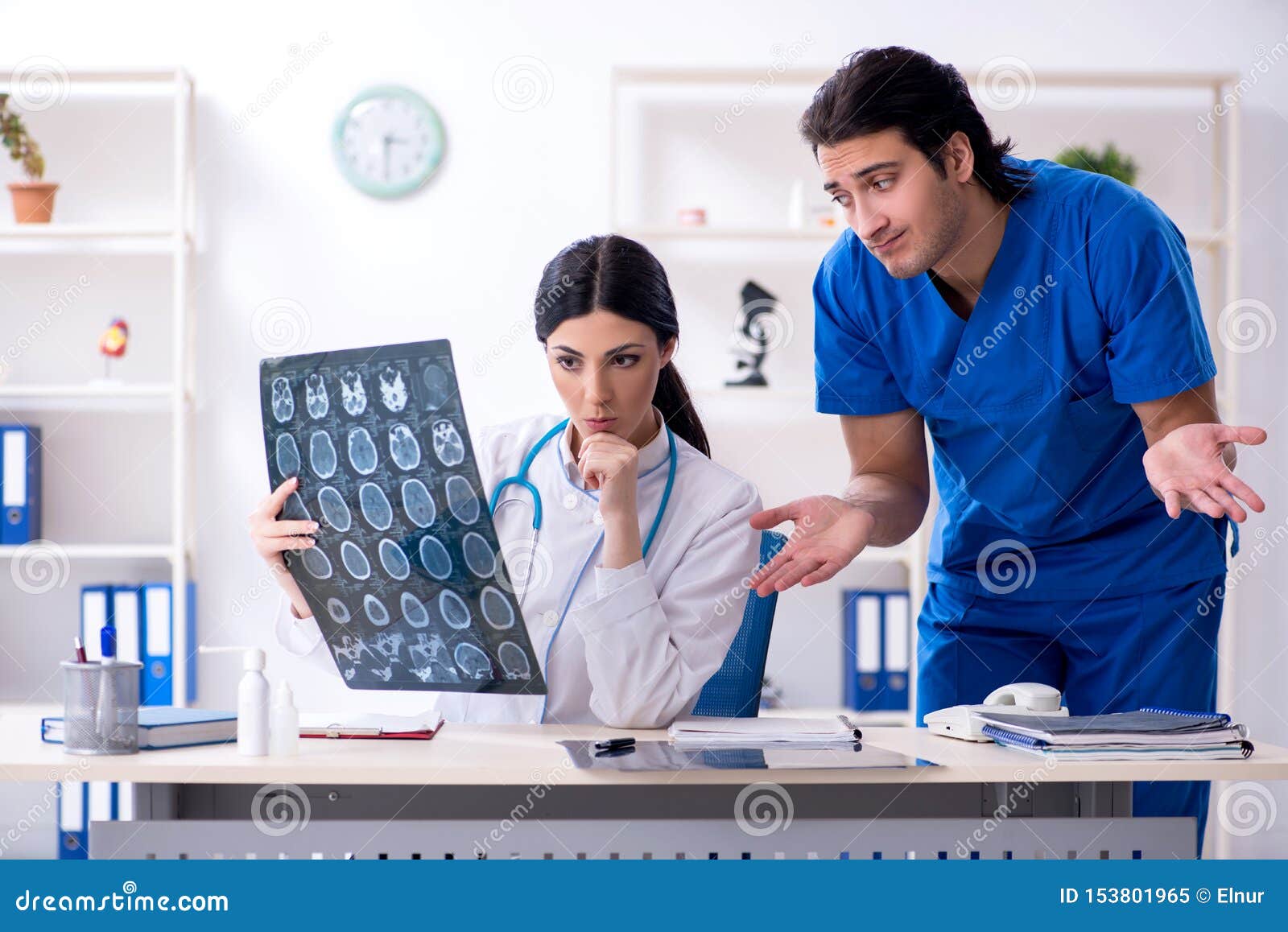 Two Young Doctors Working in the Clinic Stock Image - Image of checking ...