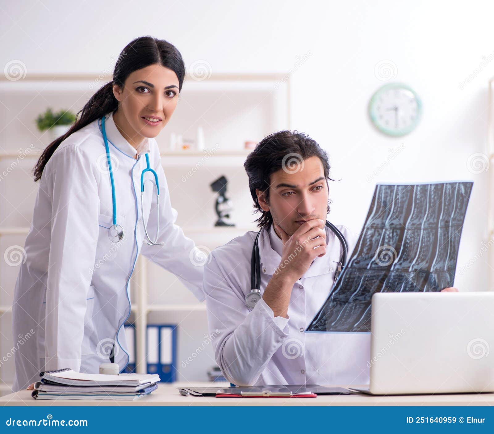 Two Young Doctors Working in the Clinic Stock Image - Image of illness ...