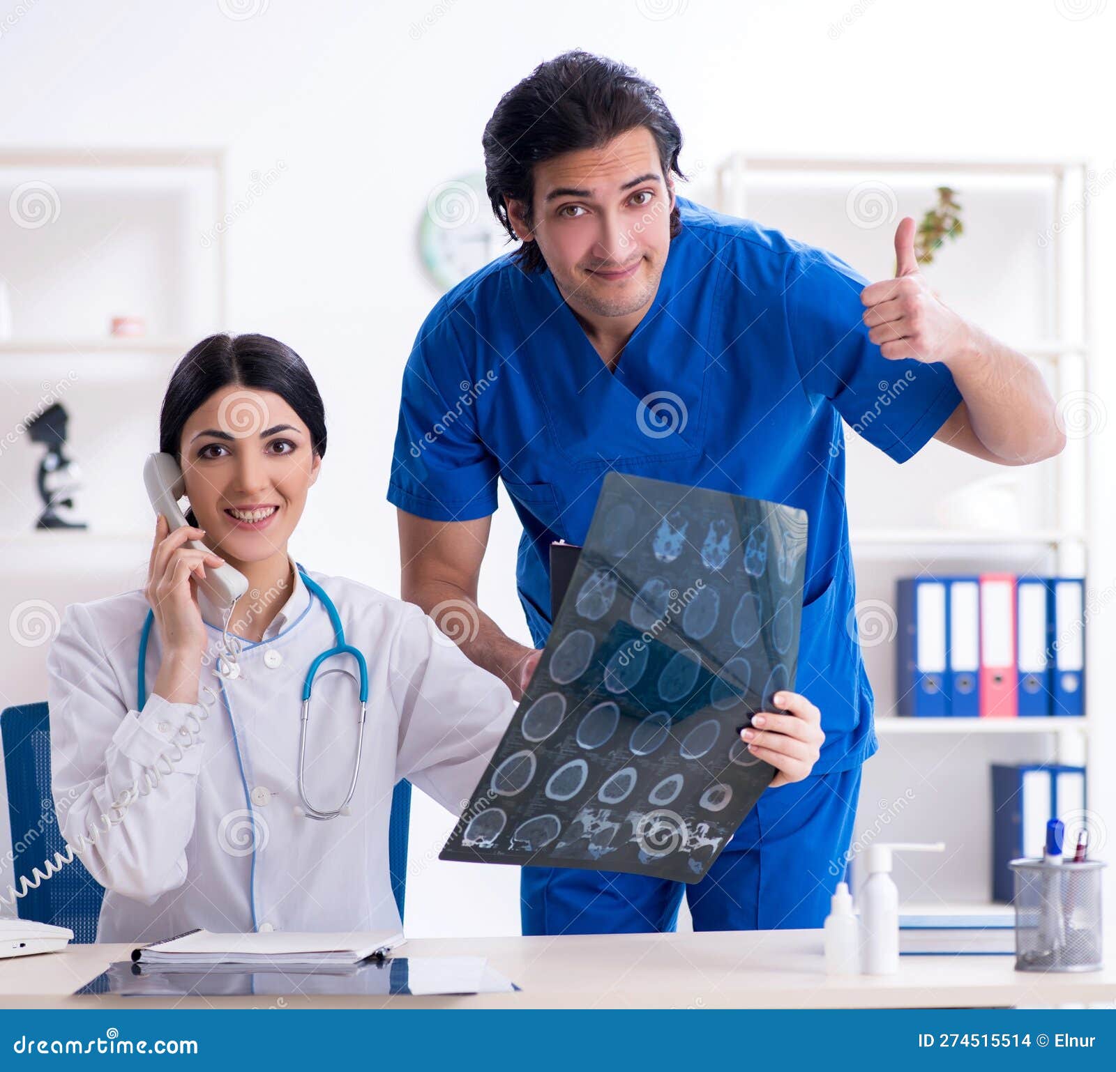 Two Young Doctors Working in the Clinic Stock Photo - Image of scan ...