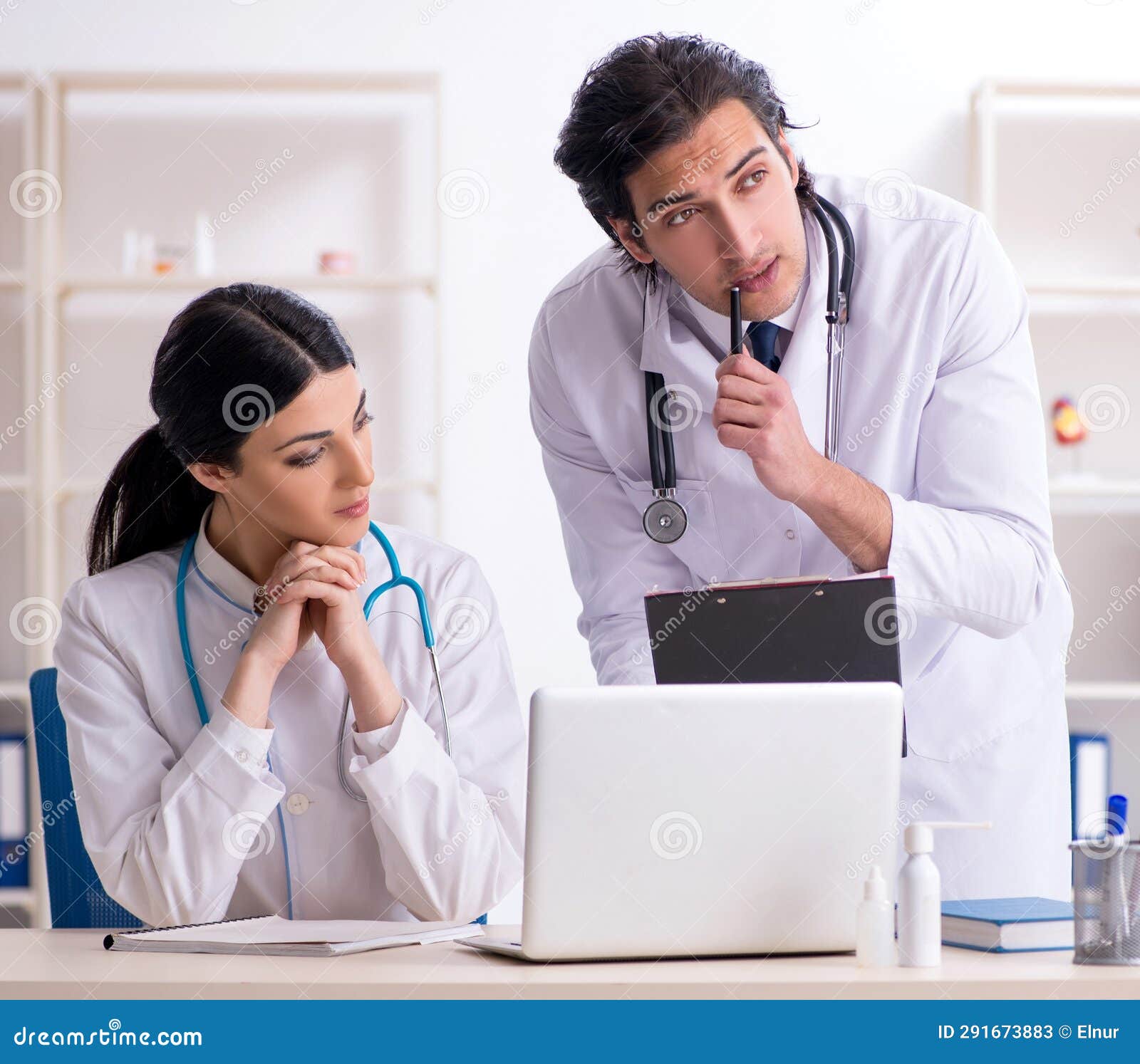 Two Young Doctors Working in the Clinic Stock Image - Image of ...