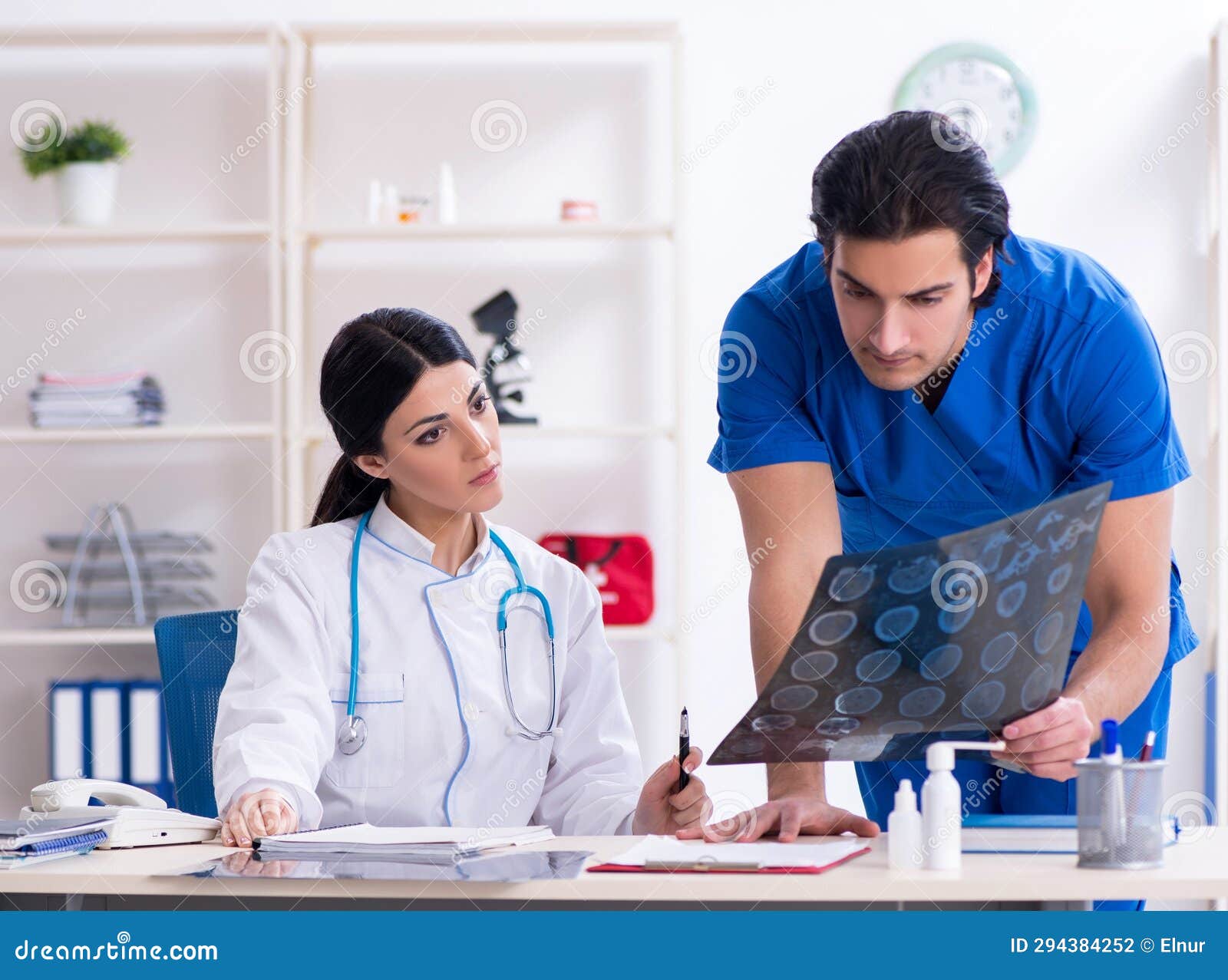 Two Young Doctors Working in the Clinic Stock Photo - Image of care ...