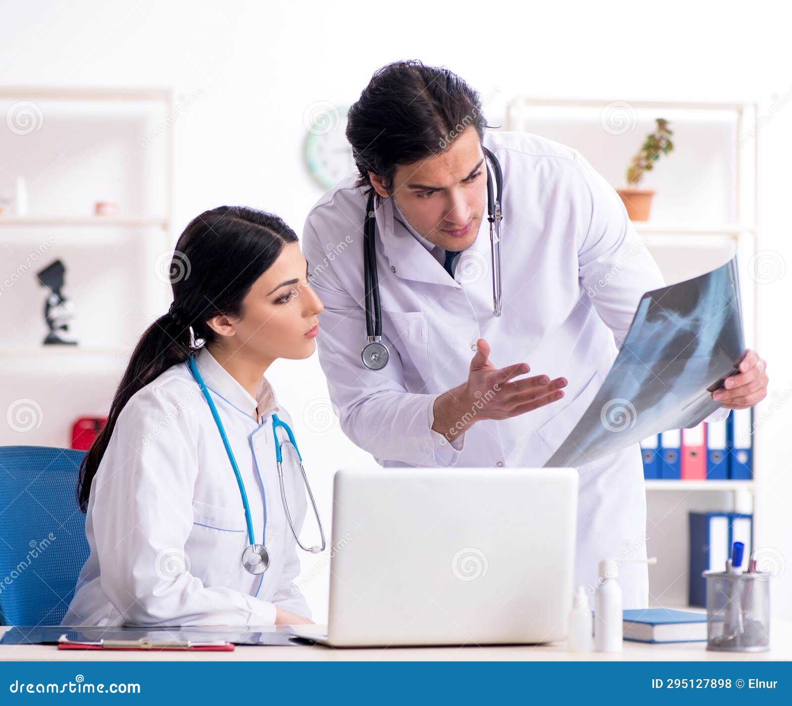 Two Young Doctors Working in the Clinic Stock Photo - Image of looking ...