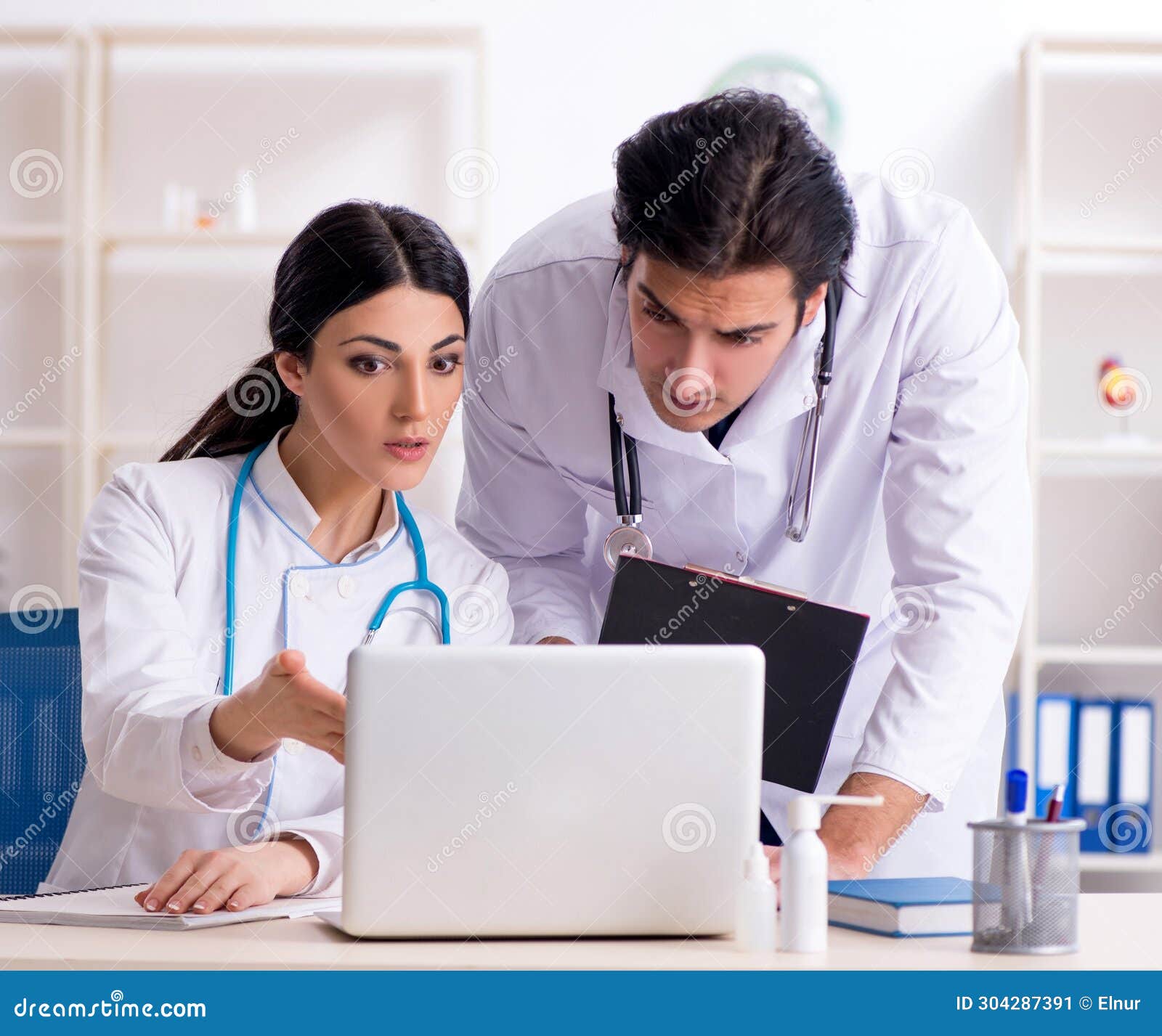 Two Young Doctors Working in the Clinic Stock Image - Image of ...