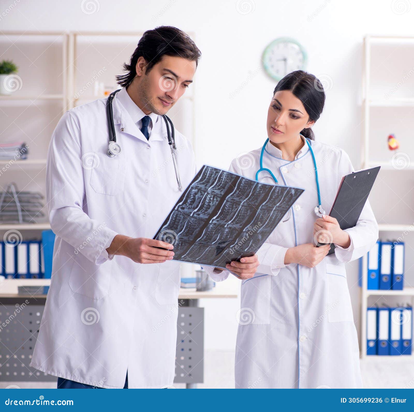 Two Young Doctors Working in the Clinic Stock Photo - Image of illness ...