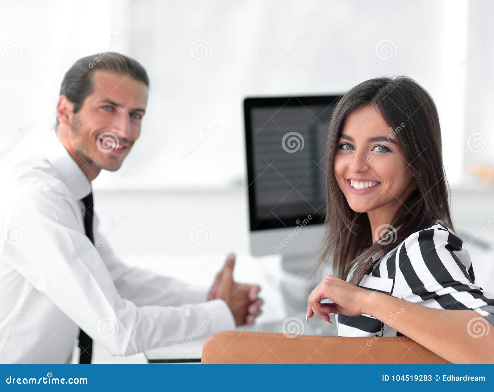 Two Young Employee Sitting Behind a Desk Stock Image - Image of ...