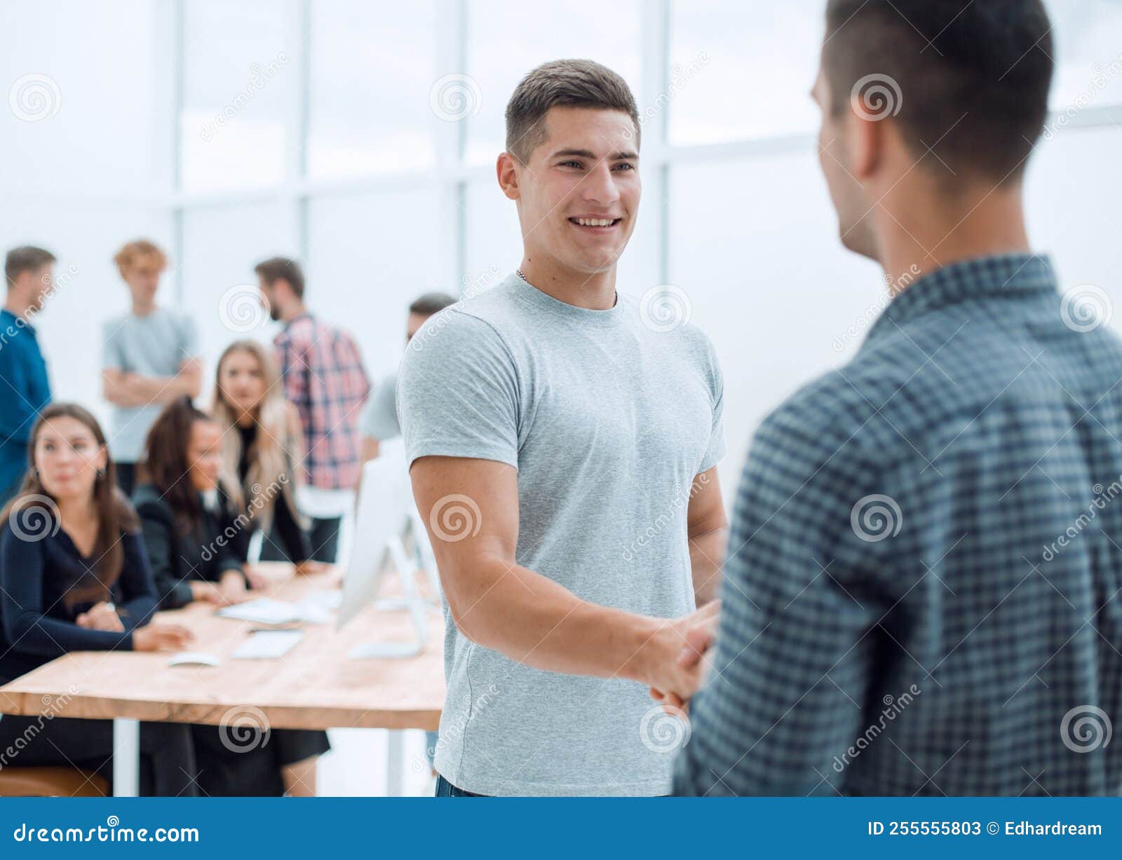 Two Young Employees Discussing a Business Document Stock Image - Image ...