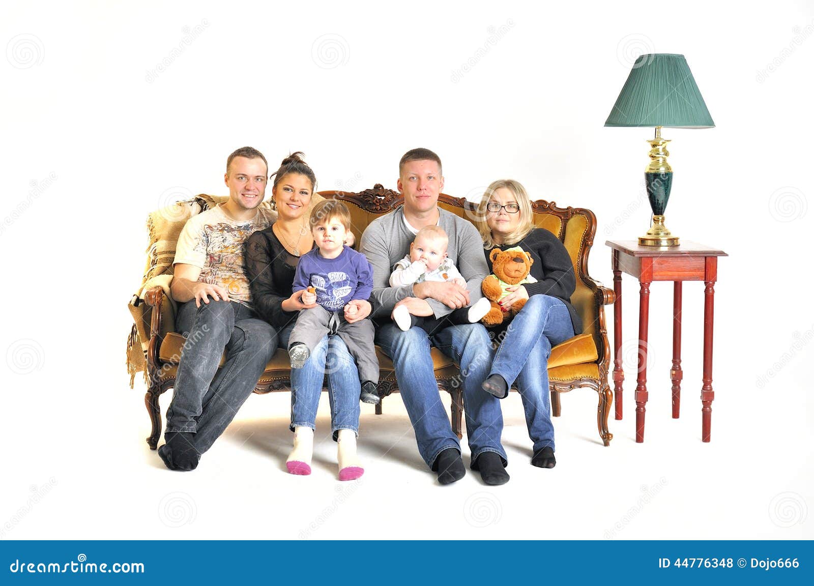 Two Young Families Play the Fool with a Child Sit on a Sofa Stock Photo ...