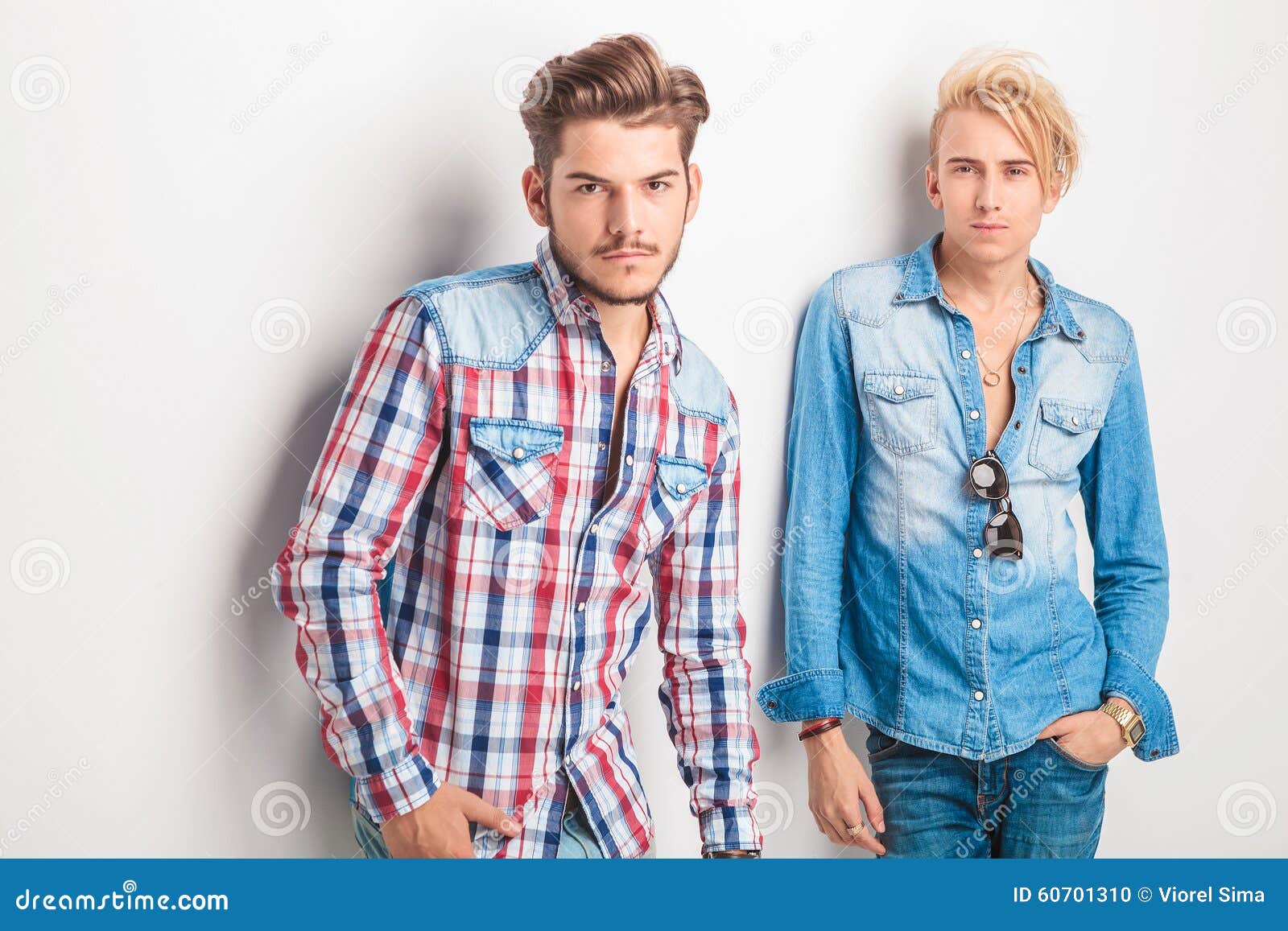 Two Young Fashion Men Standing Against Studio Wall Stock Photo - Image ...