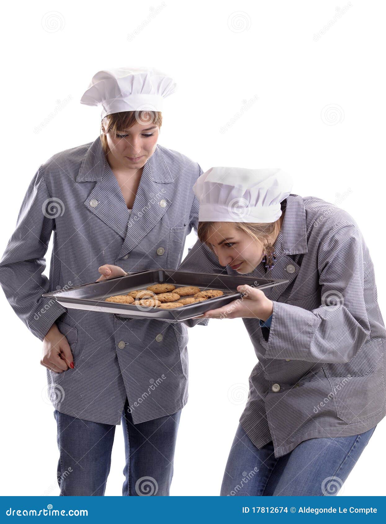 Two Young Female Cooks Inspecting Cookies Stock Photo - Image of woman ...