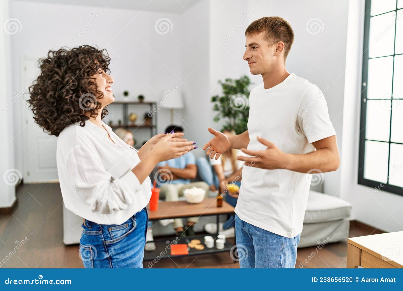 Two Young Friends Standing and Speaking at Home Stock Photo - Image of ...