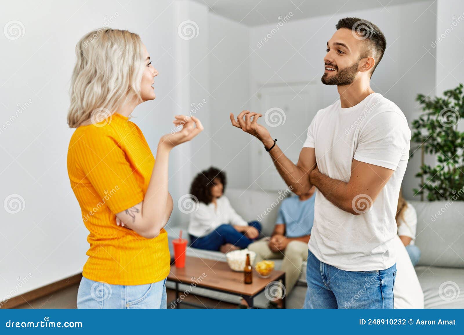 Two Young Friends Standing and Speaking at Home Stock Photo - Image of ...