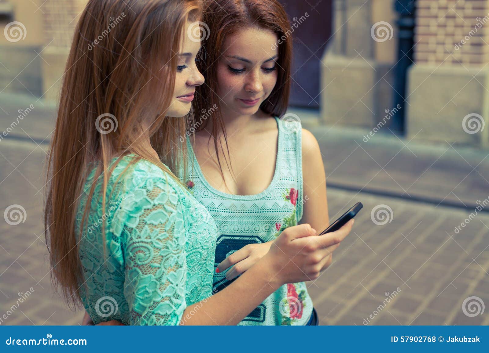 Two Young Girl Using GPS in Mobile Phone. Urban Backbround. Stock Photo ...