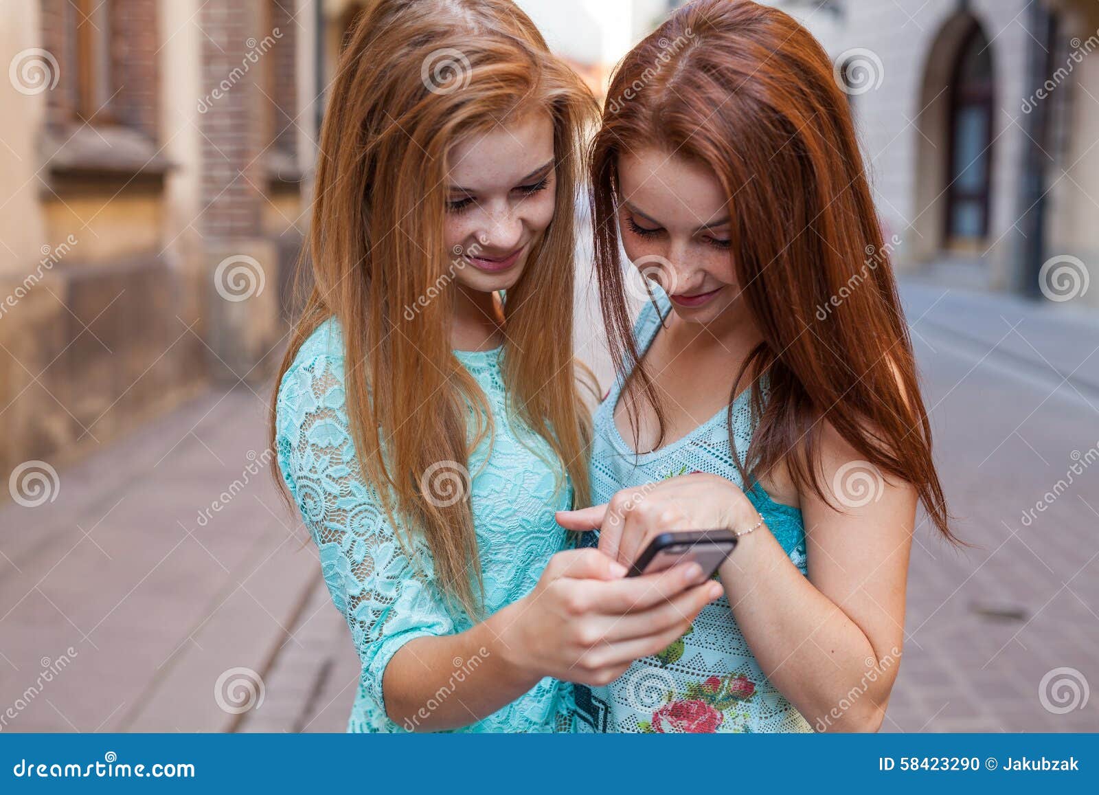 Two Young Girl Using GPS in Mobile Phone. Urban Backbround. Stock Photo ...