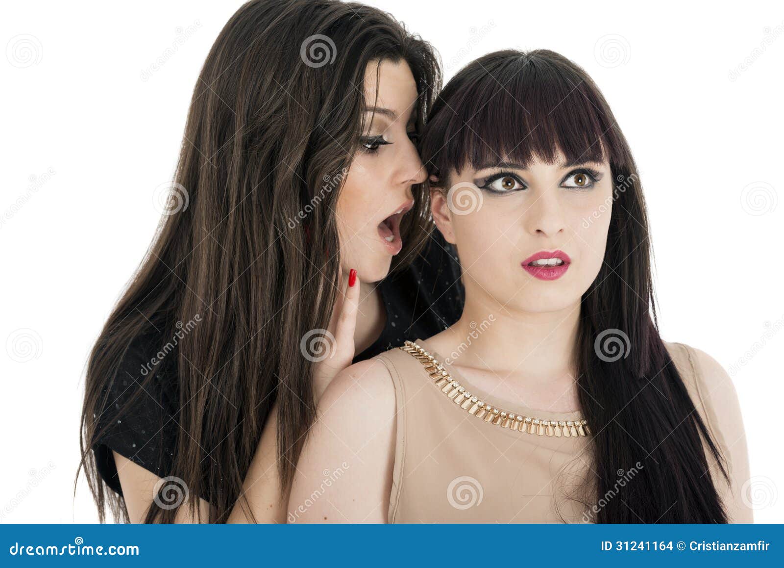 Two Young Girlfriends Sharing Their Secrets, Studio Shot Stock Photo ...