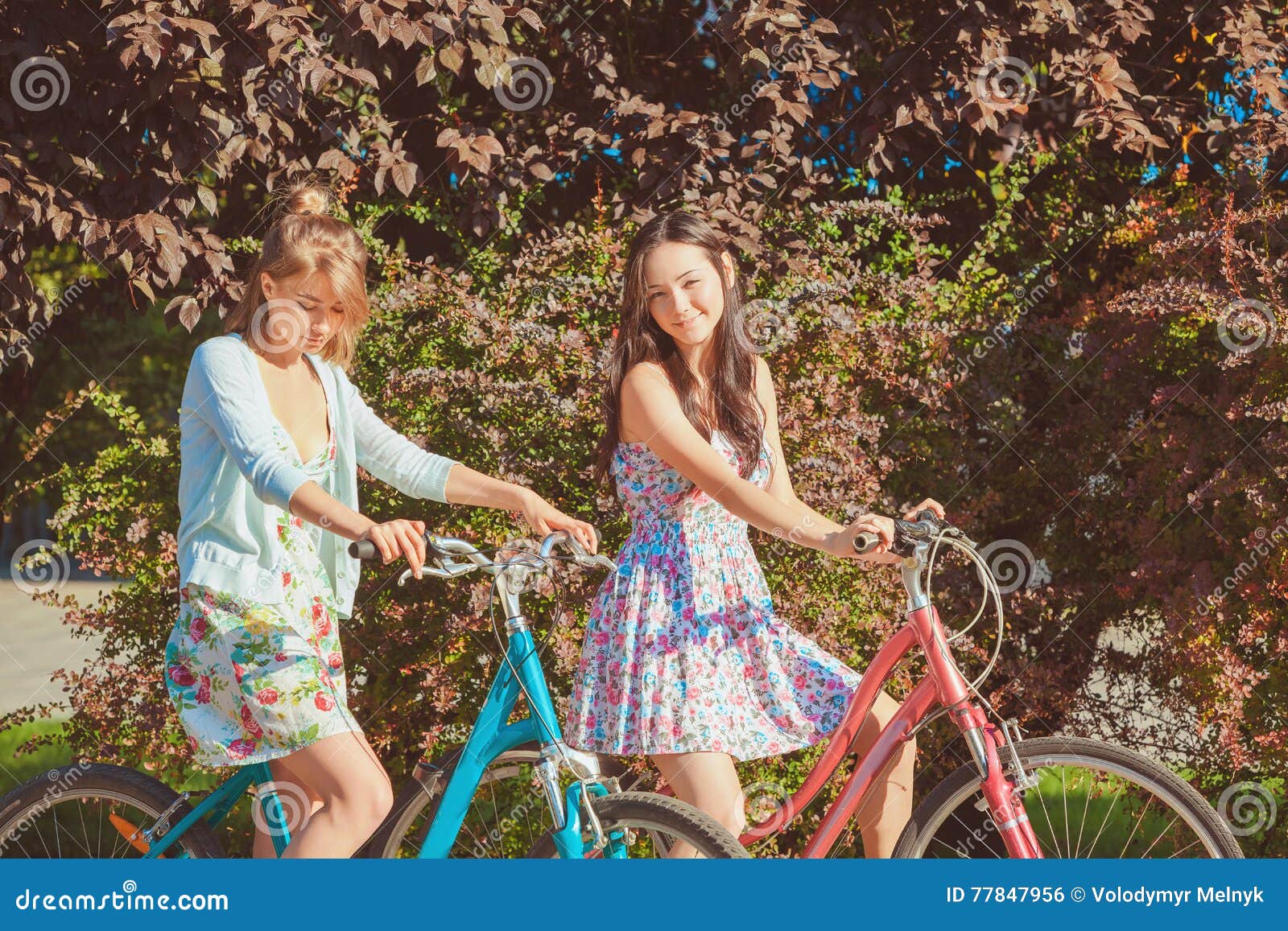 The Two Young Girls with Bicycles in Park Stock Photo - Image of ...