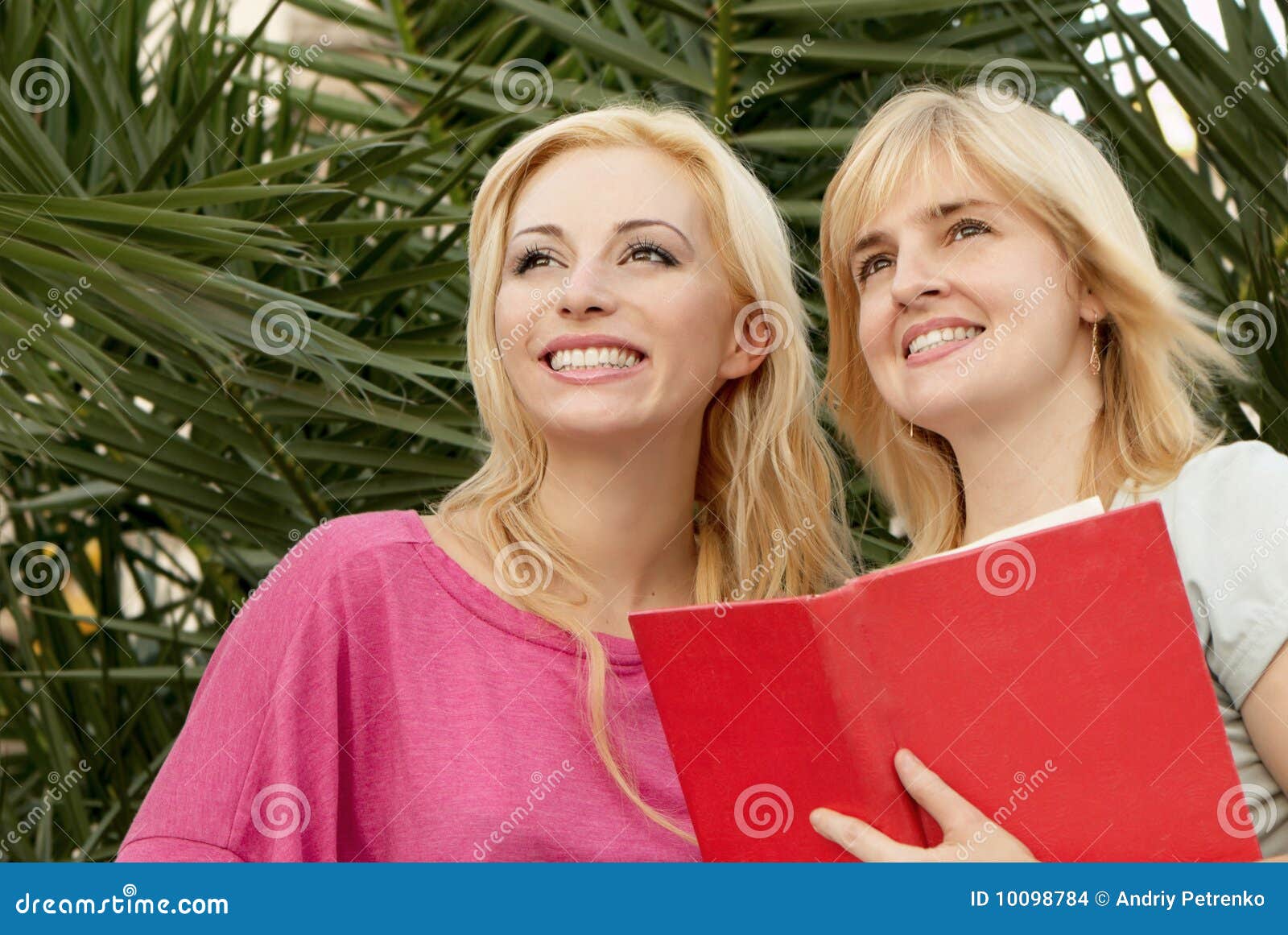 Two Young Girls with the Book Stock Photo - Image of holding, friendly ...