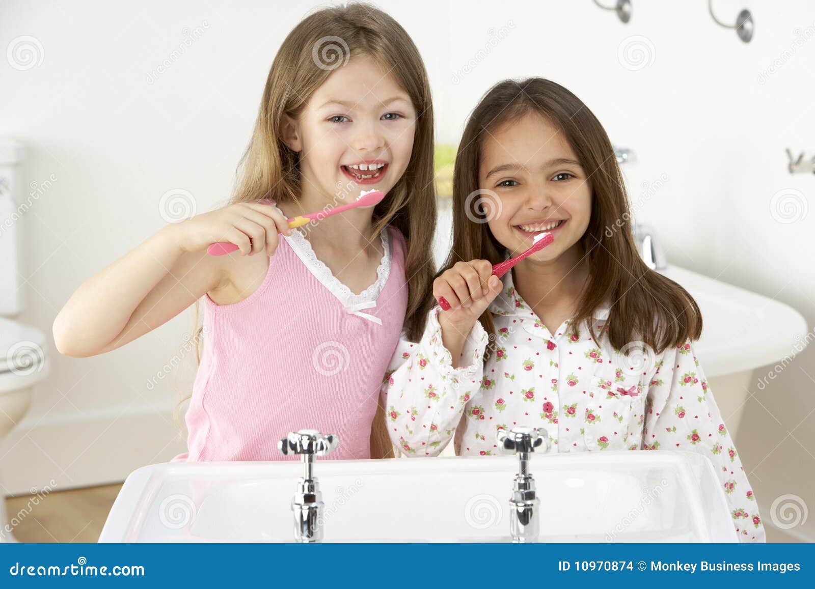 Two Young Girls Brushing Teeth at Sink Stock Photo - Image of seven ...