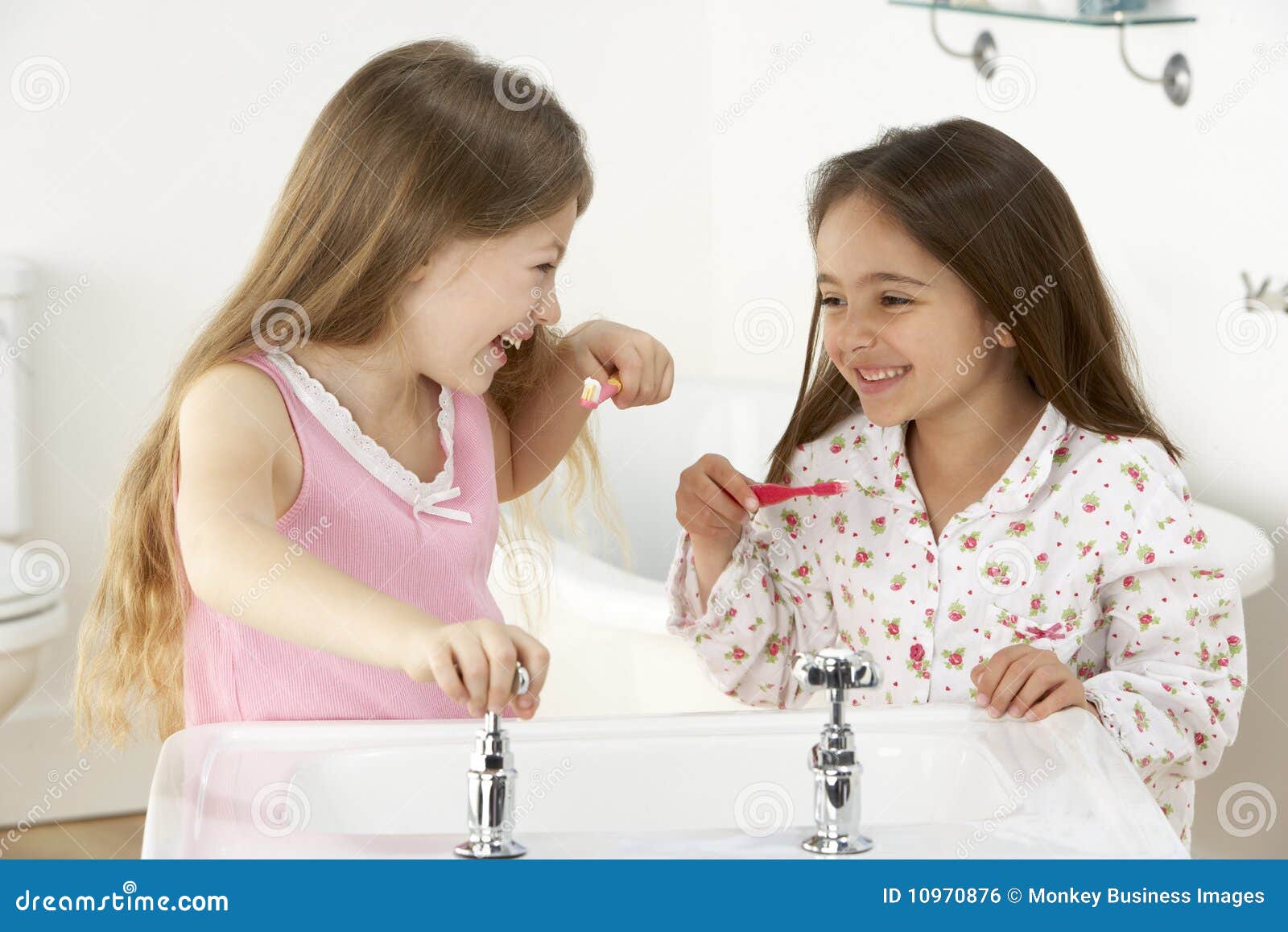 Two Young Girls Brushing Teeth at Sink Stock Photo - Image of home ...