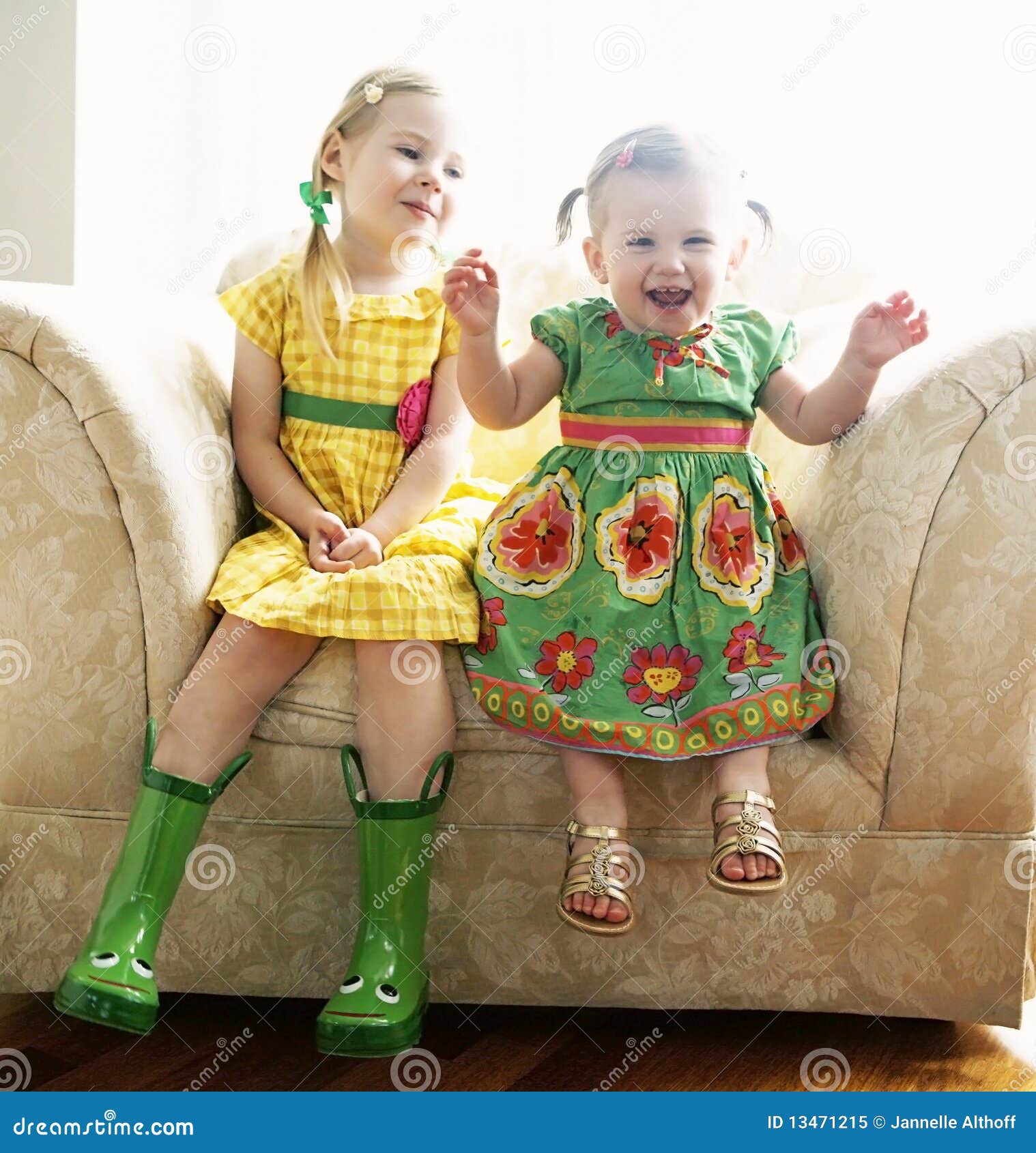 Two young girls on chair stock image. Image of child - 13471215