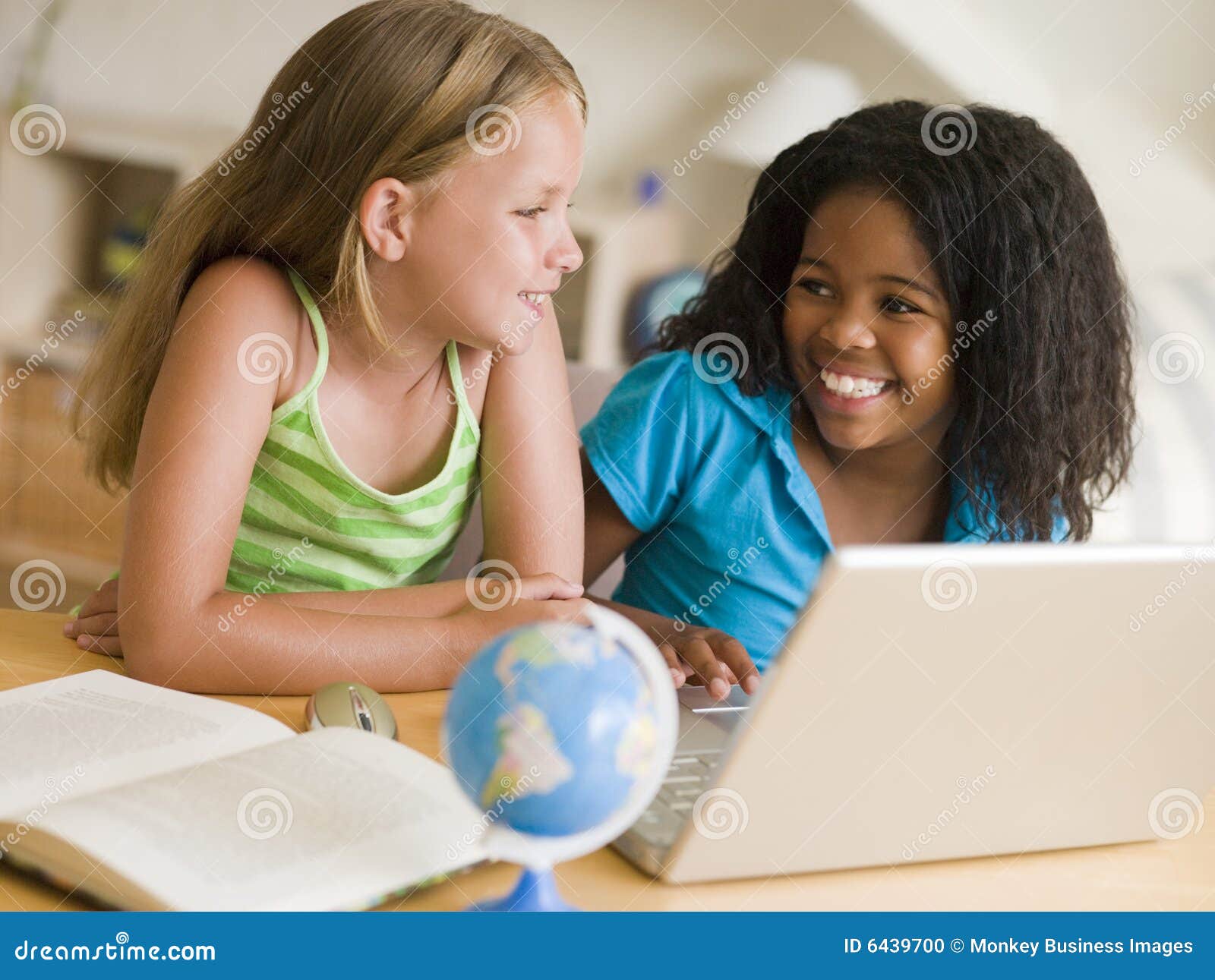 Two Young Girls Doing Their Homework on a Laptop Stock Photo - Image of ...