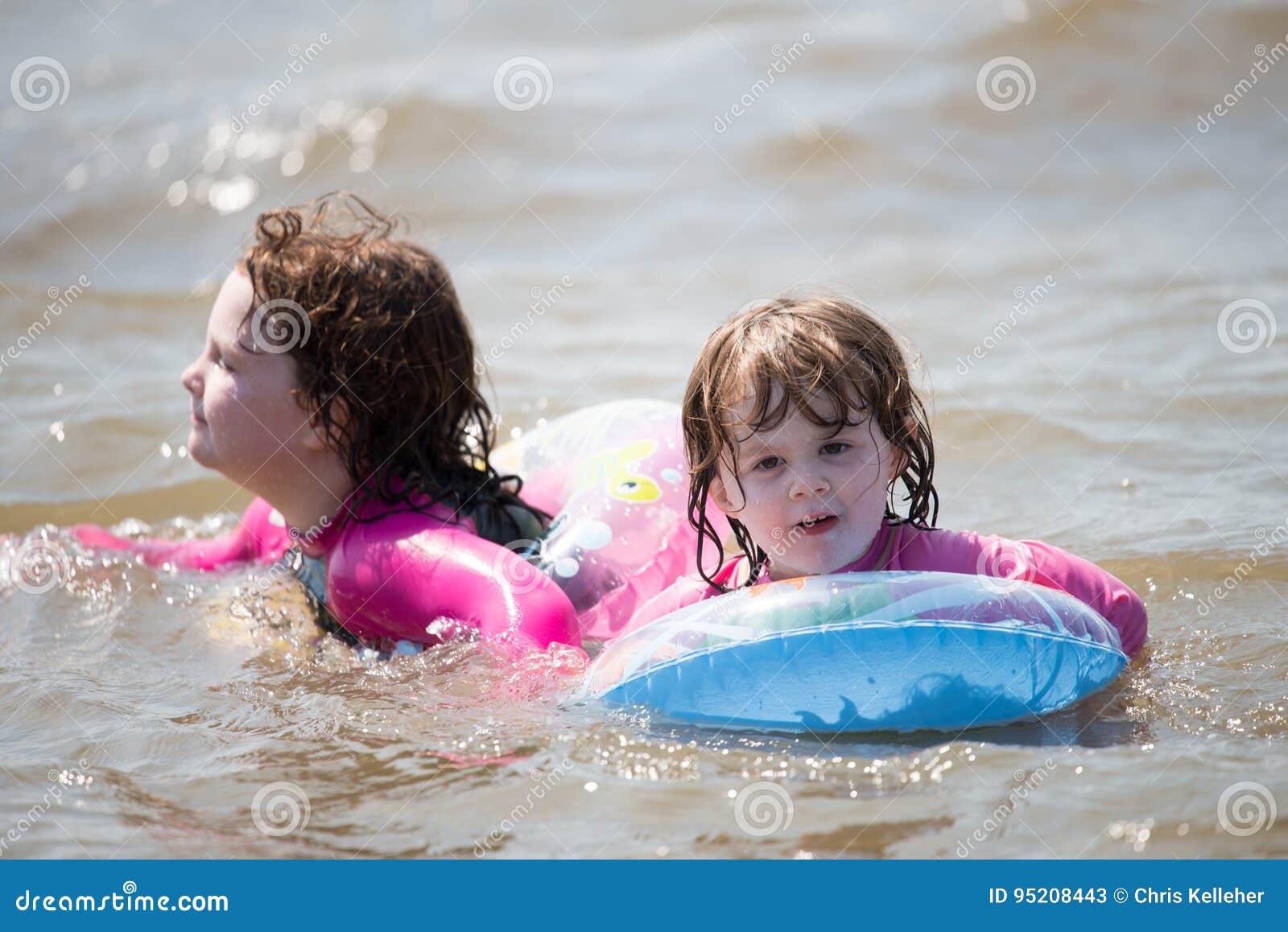 Two Young Girls Floating in Inner Tubes in a Blissful State Stock Image ...