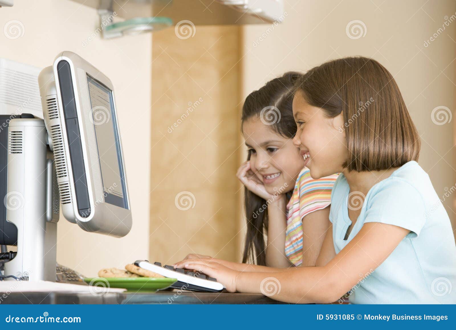 Two Young Girls in Kitchen with Computer Smiling Stock Image - Image of ...