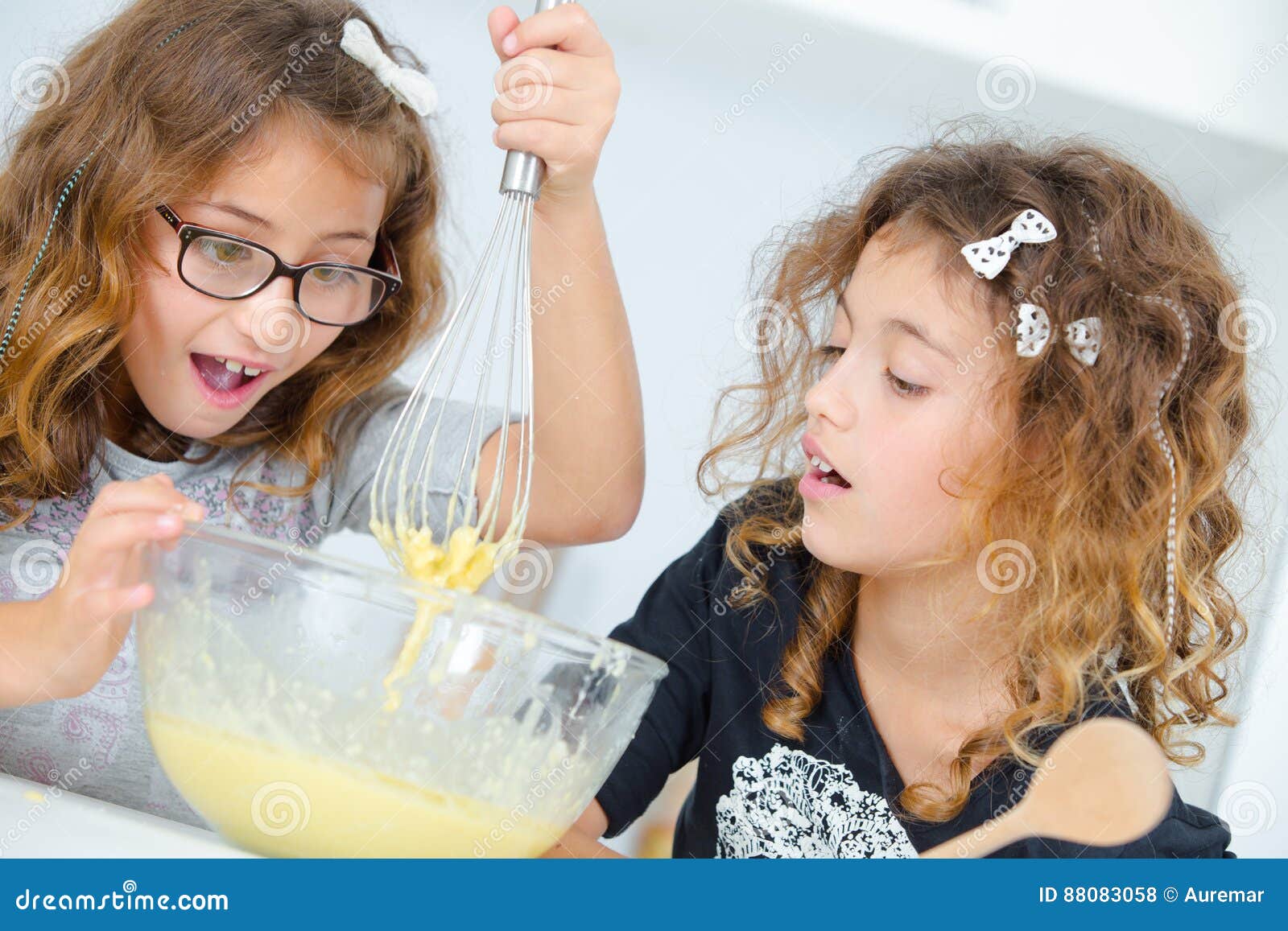 Two Young Girls Making on Cake on Their Own at Stock Photo - Image of ...