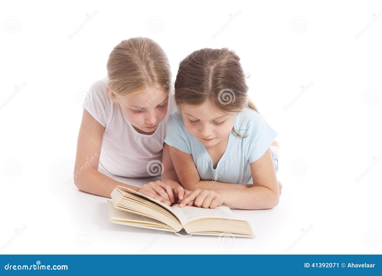 Two Young Girls Reading a Book Together Stock Image - Image of cute ...