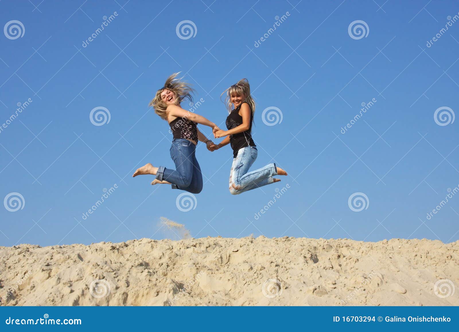 Two Young Girls on a Sand-pit Stock Photo - Image of blue, woman: 16703294