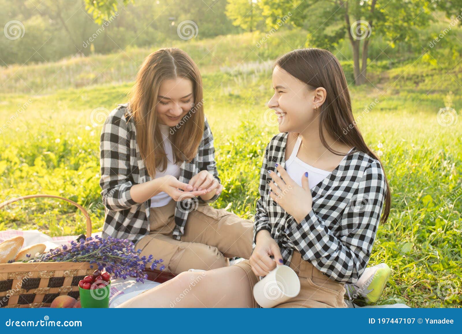 Two Young Girls Sisters on a Picnic Eating, Drinking Lemonade Stock ... Two Young Girls Sisters on a Picnic Eating, Drinking Lemonade Stock ...