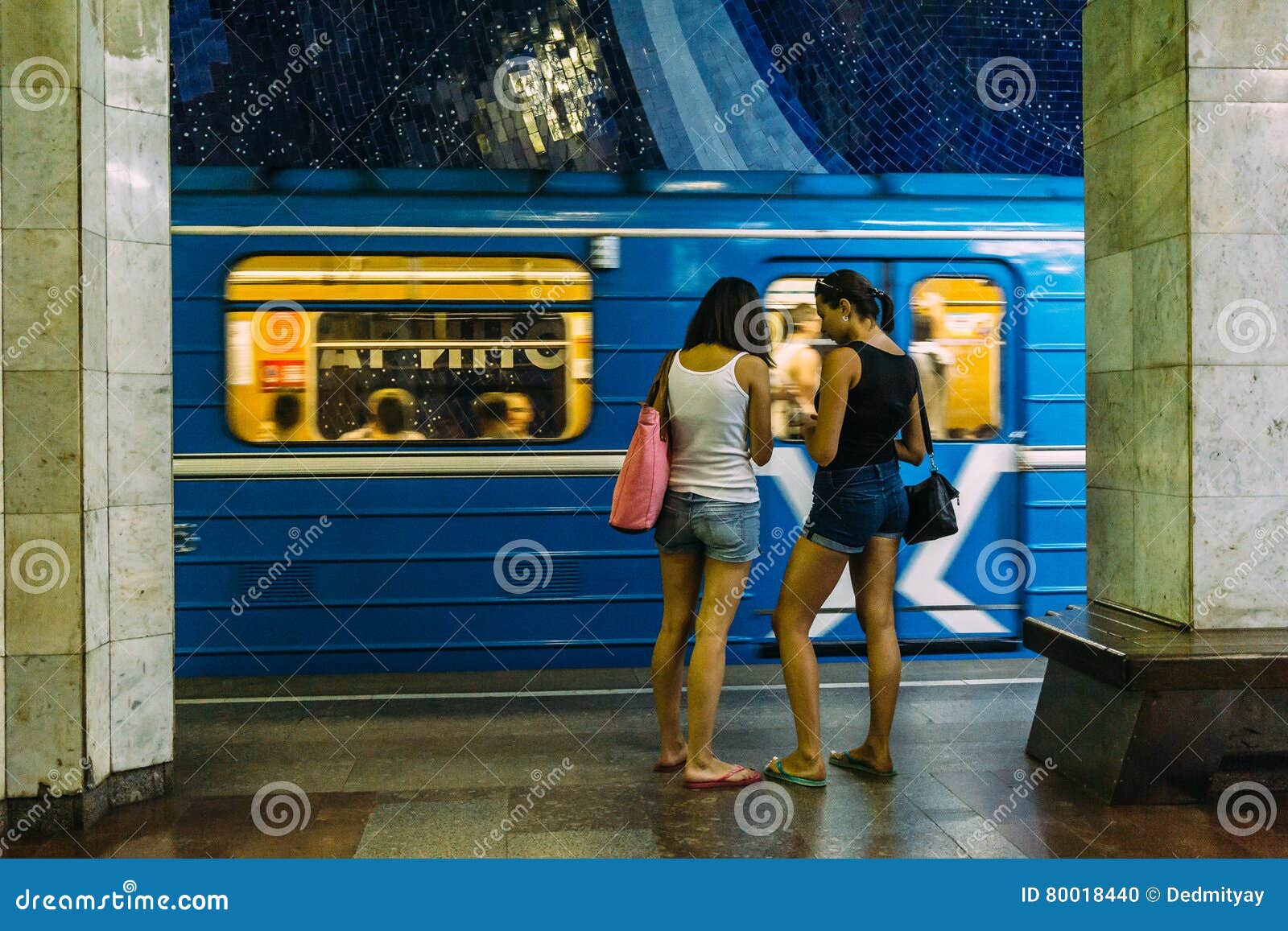 Two Young Girls Standing on Underground Station on Background of Riding ...