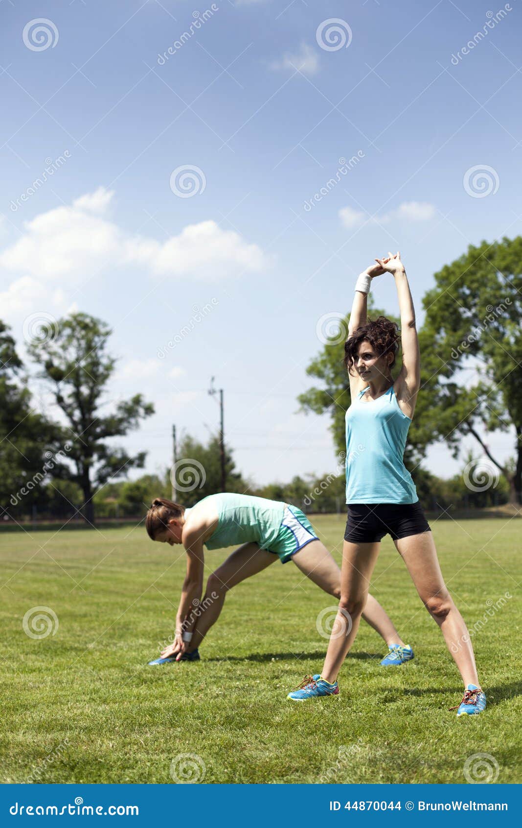 Two Young Girls Stetching before a Jogging Stock Photo - Image of ...