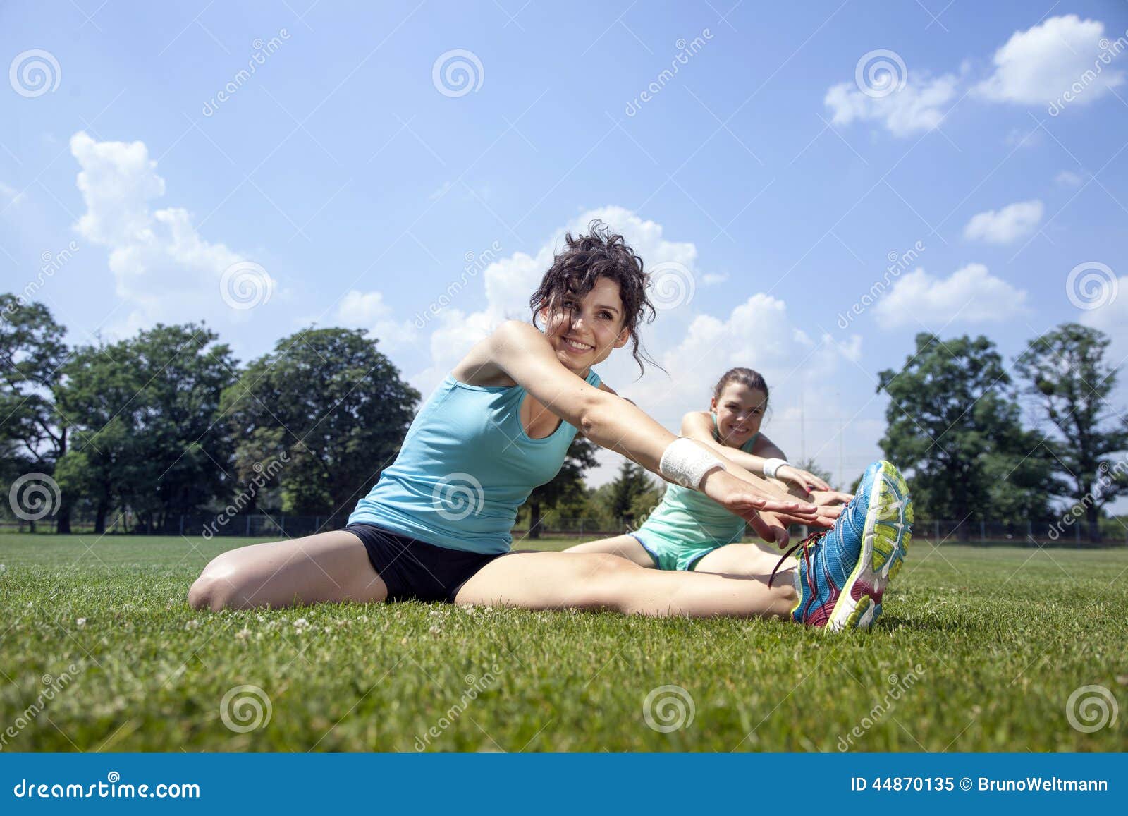 Two young girls stetching stock image. Image of person - 44870135