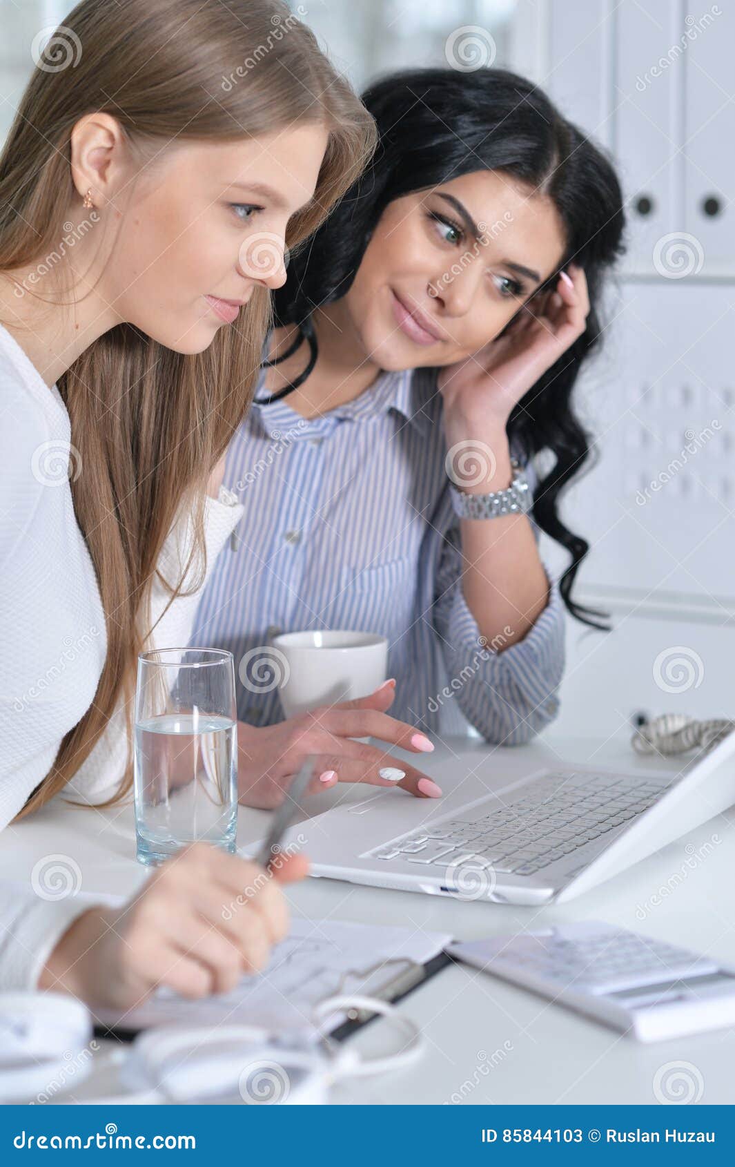 Two young girls working stock image. Image of interior - 85844103