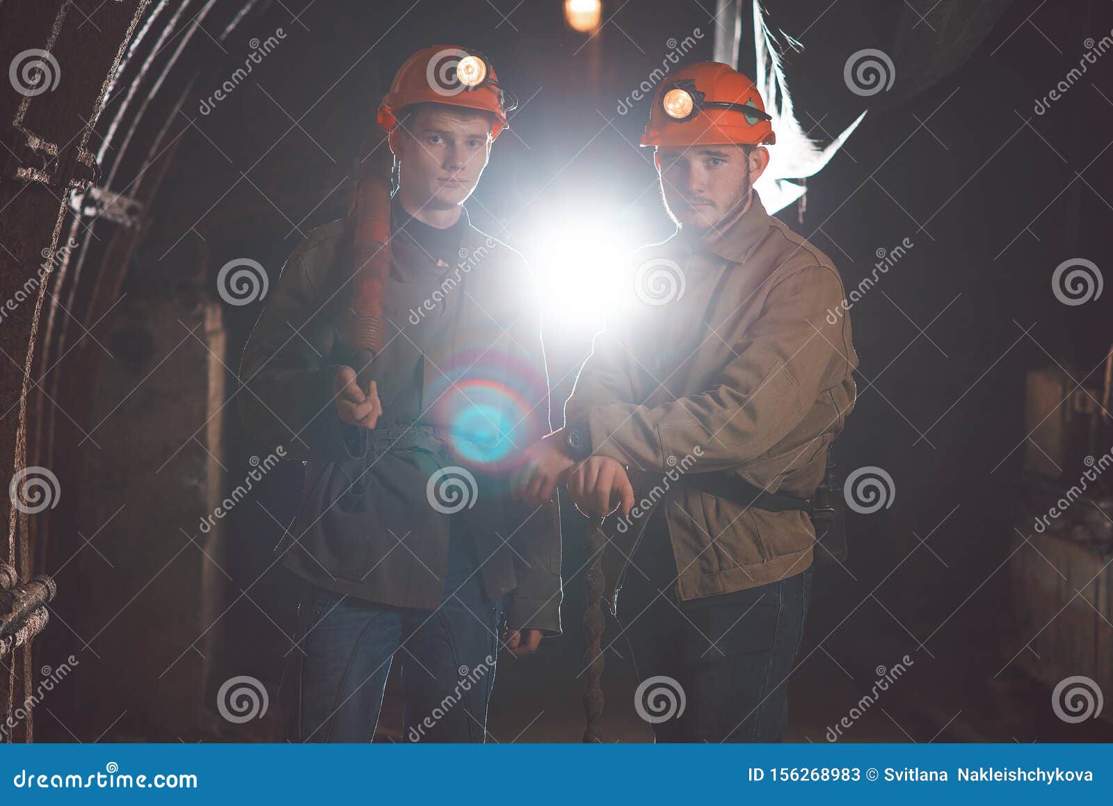 Two Young Guys in Special Clothes and Helmets Standing in the Mine ...
