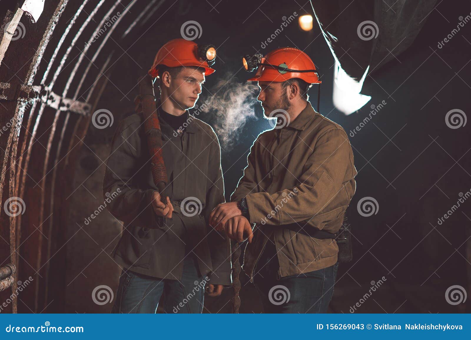 Two Young Guys in Special Clothes and Helmets Standing in the Mine ...
