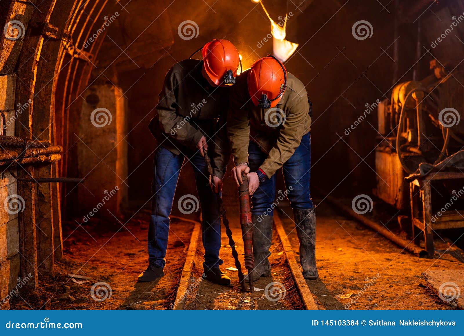 Two Young Guys in a Working Uniform and Protective Helmets, Carry Out ...